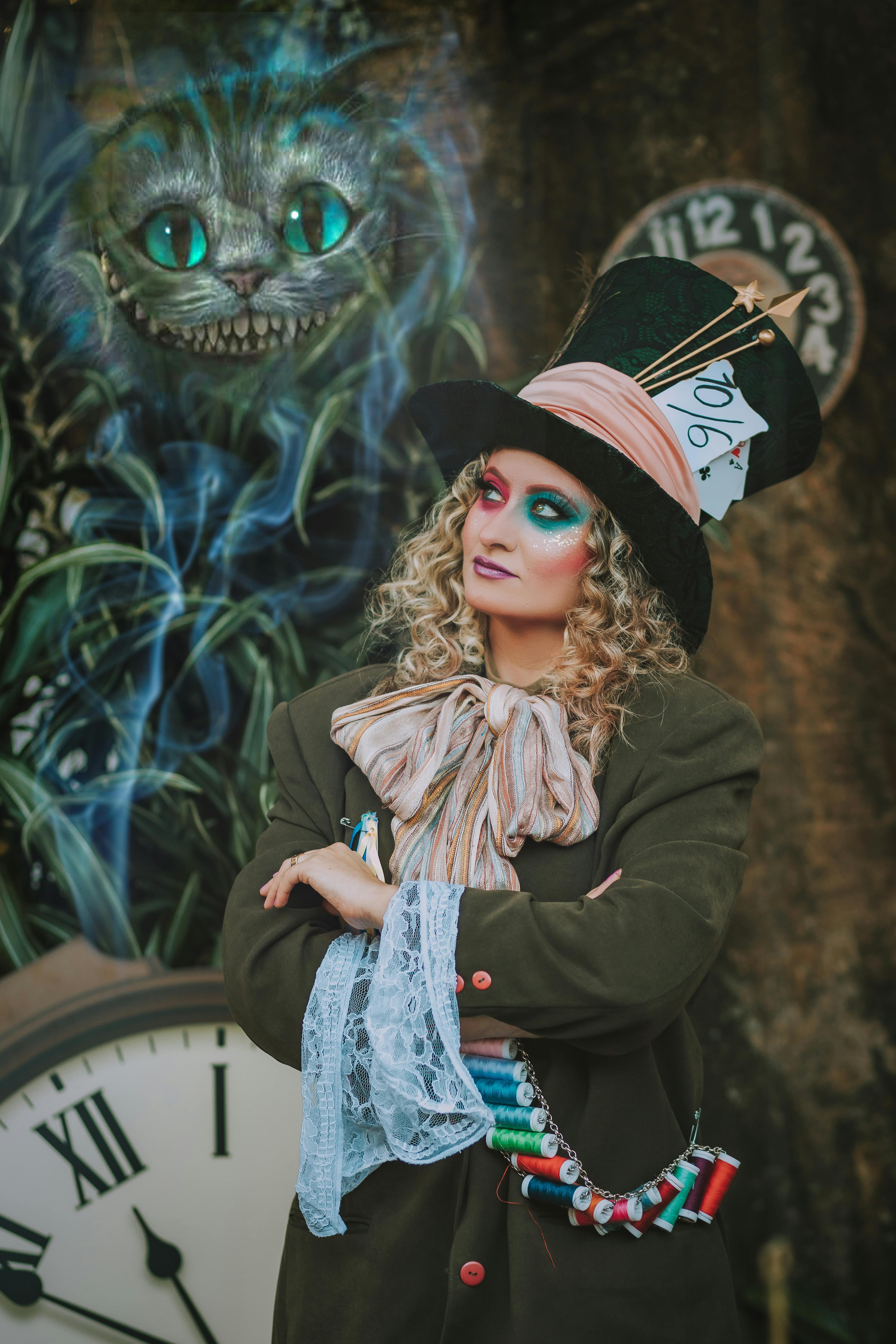 Young Woman Cosplaying the Mad Hatter Looking at a Floating Image of ...
