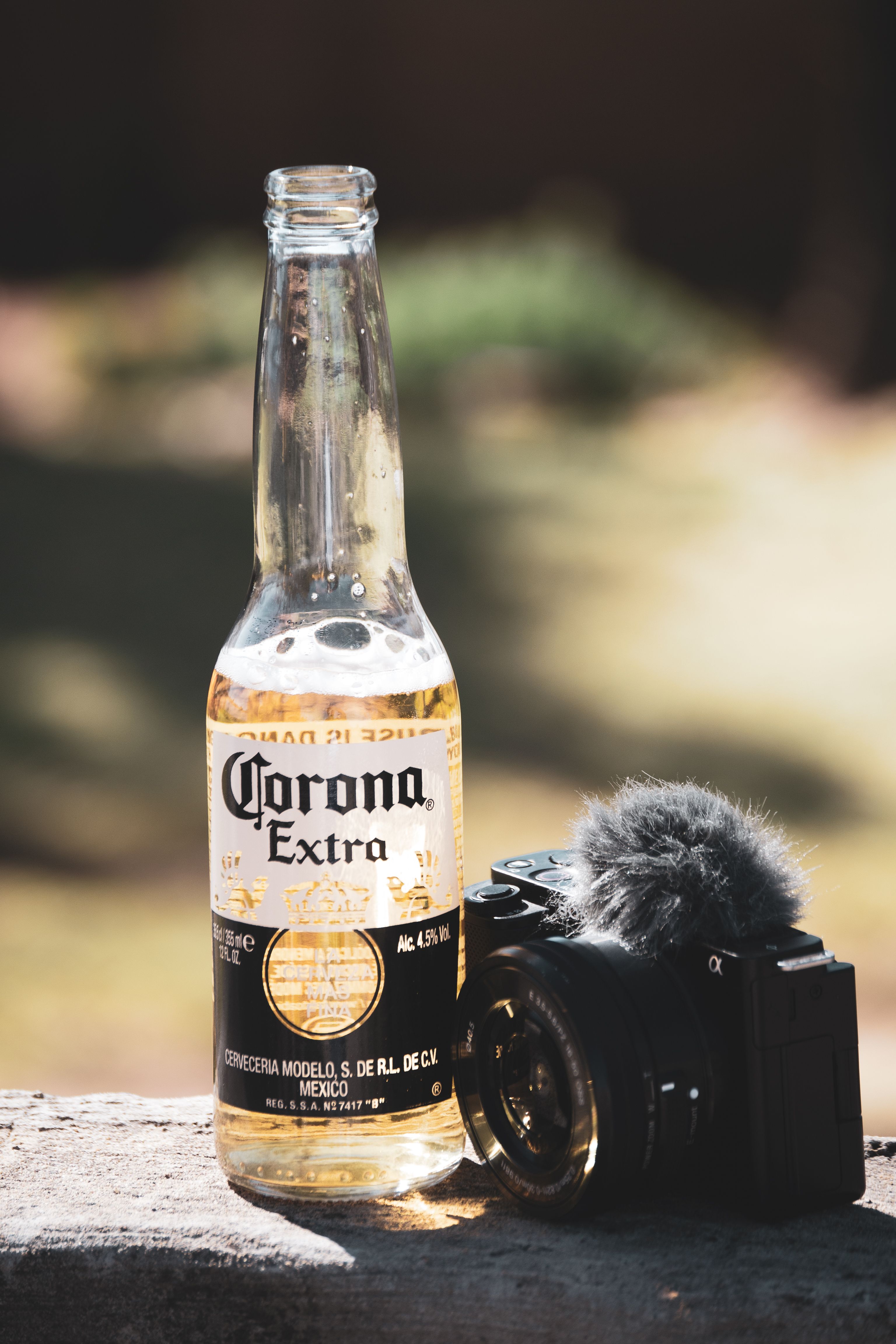 Camera and Bottle of Beer · Free Stock Photo