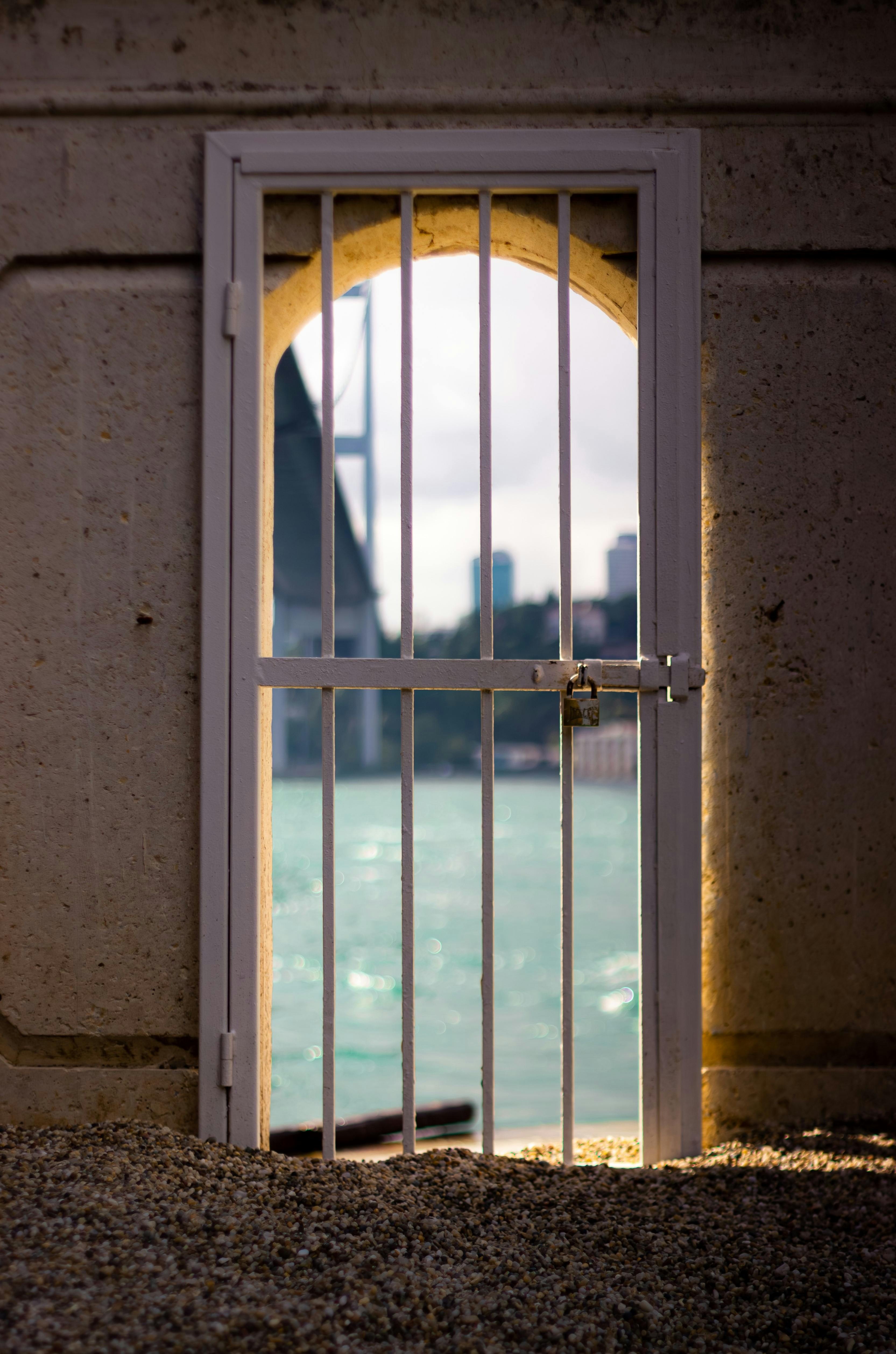 A view of the water through a window in a building · Free Stock Photo