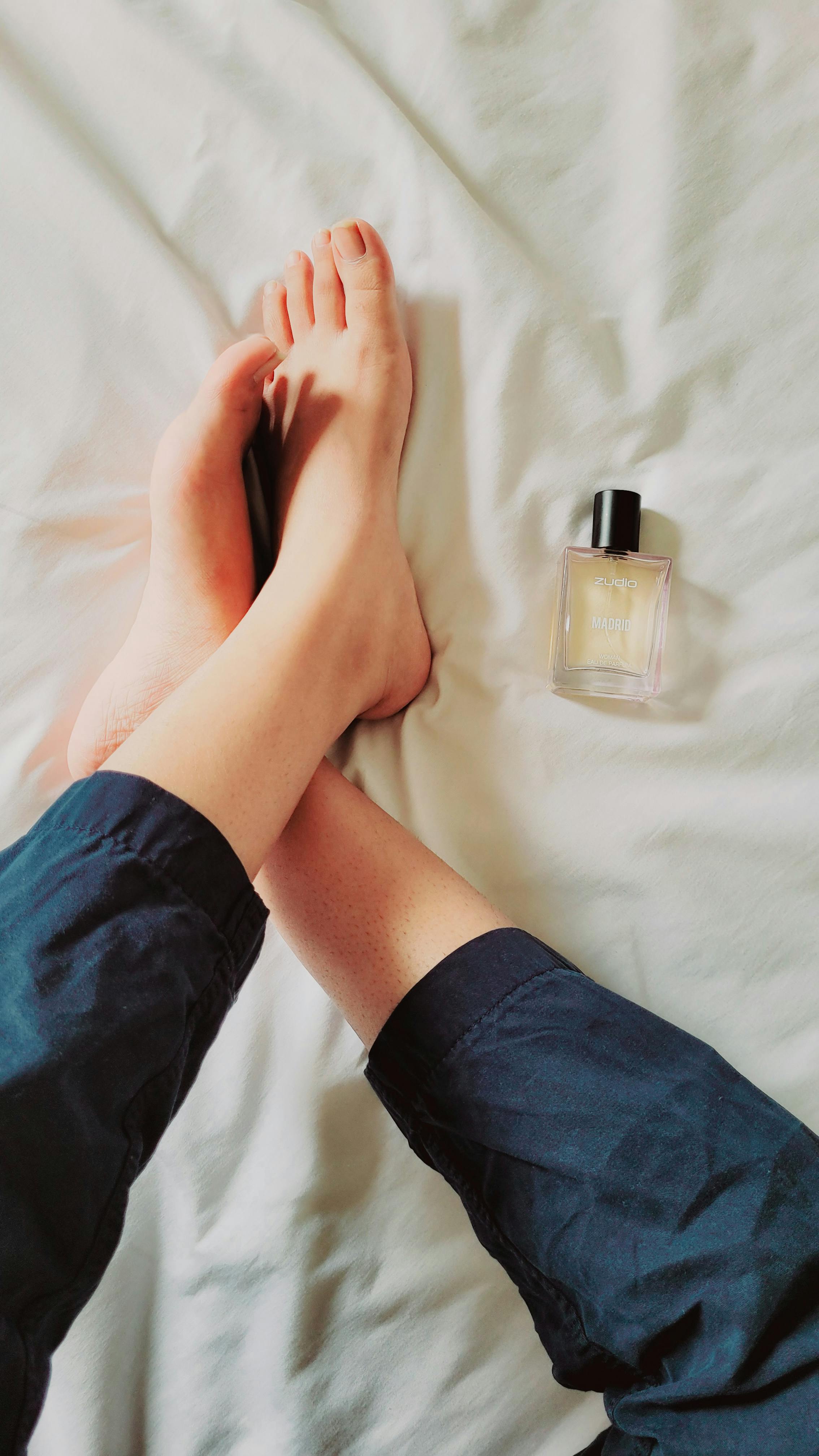 Woman Feet and Perfume Vial · Free Stock Photo