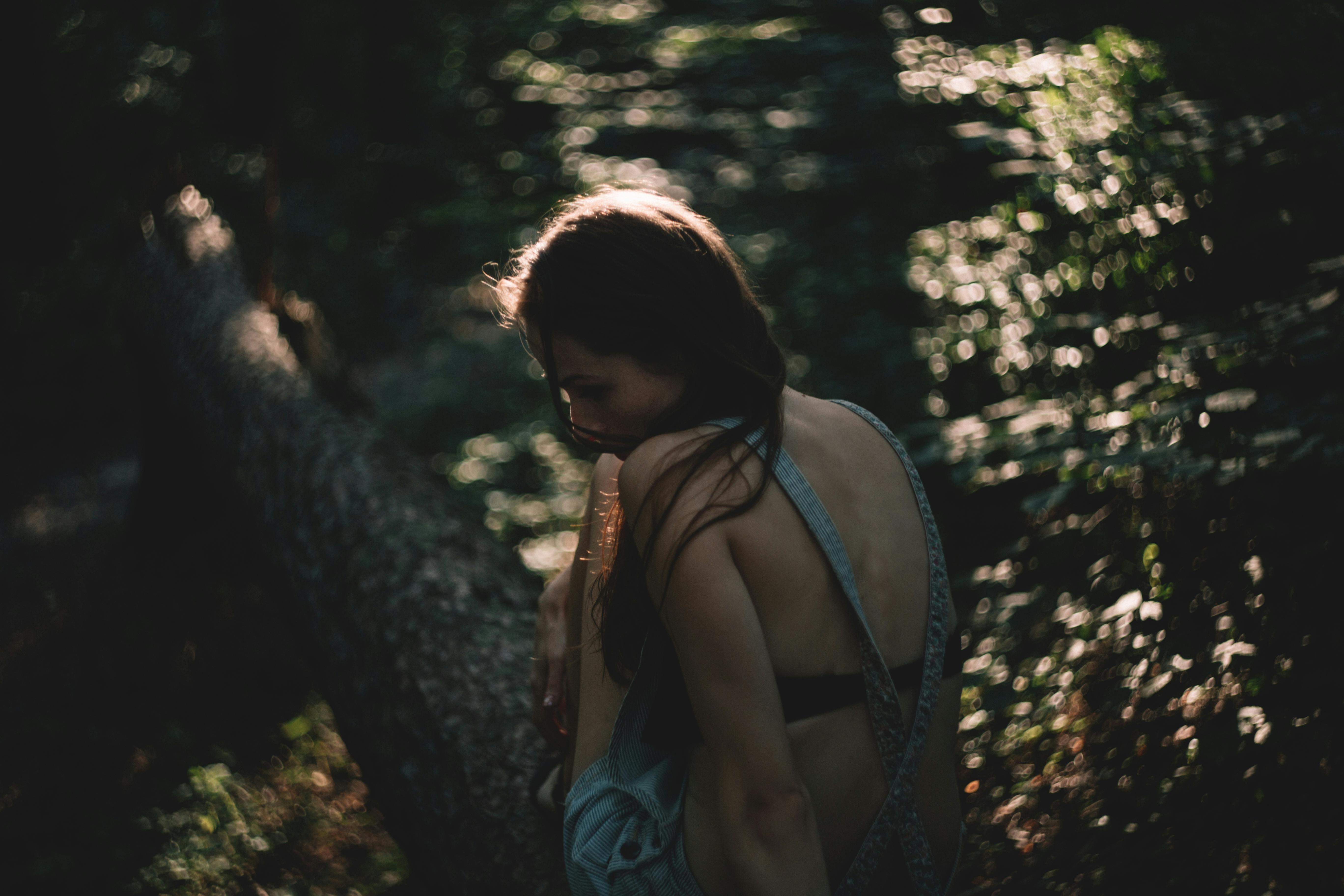 Woman Sitting on Tree Trunk during Daytime · Free Stock Photo