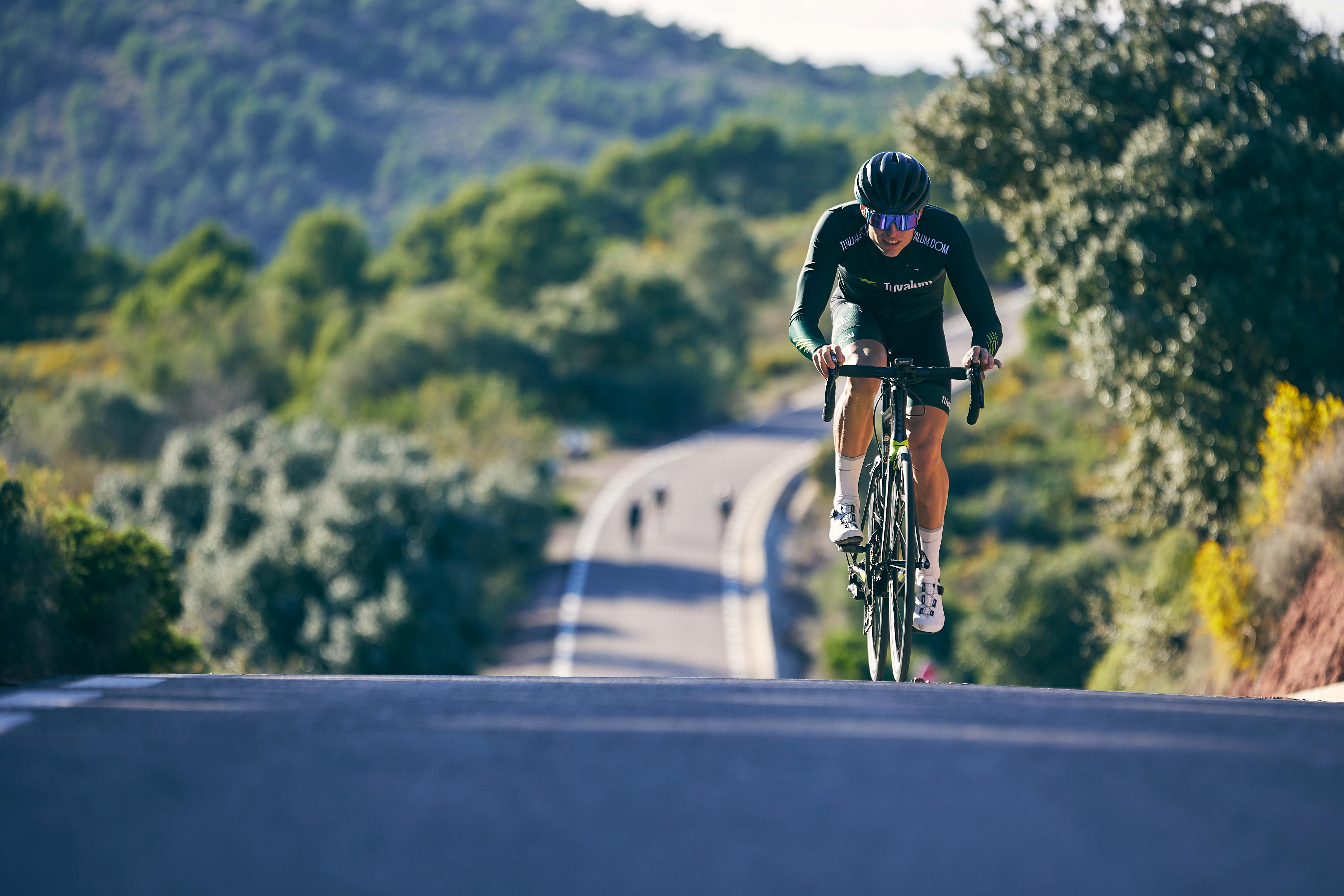 Cyclist Riding Road Bike on Hill · Free Stock Photo