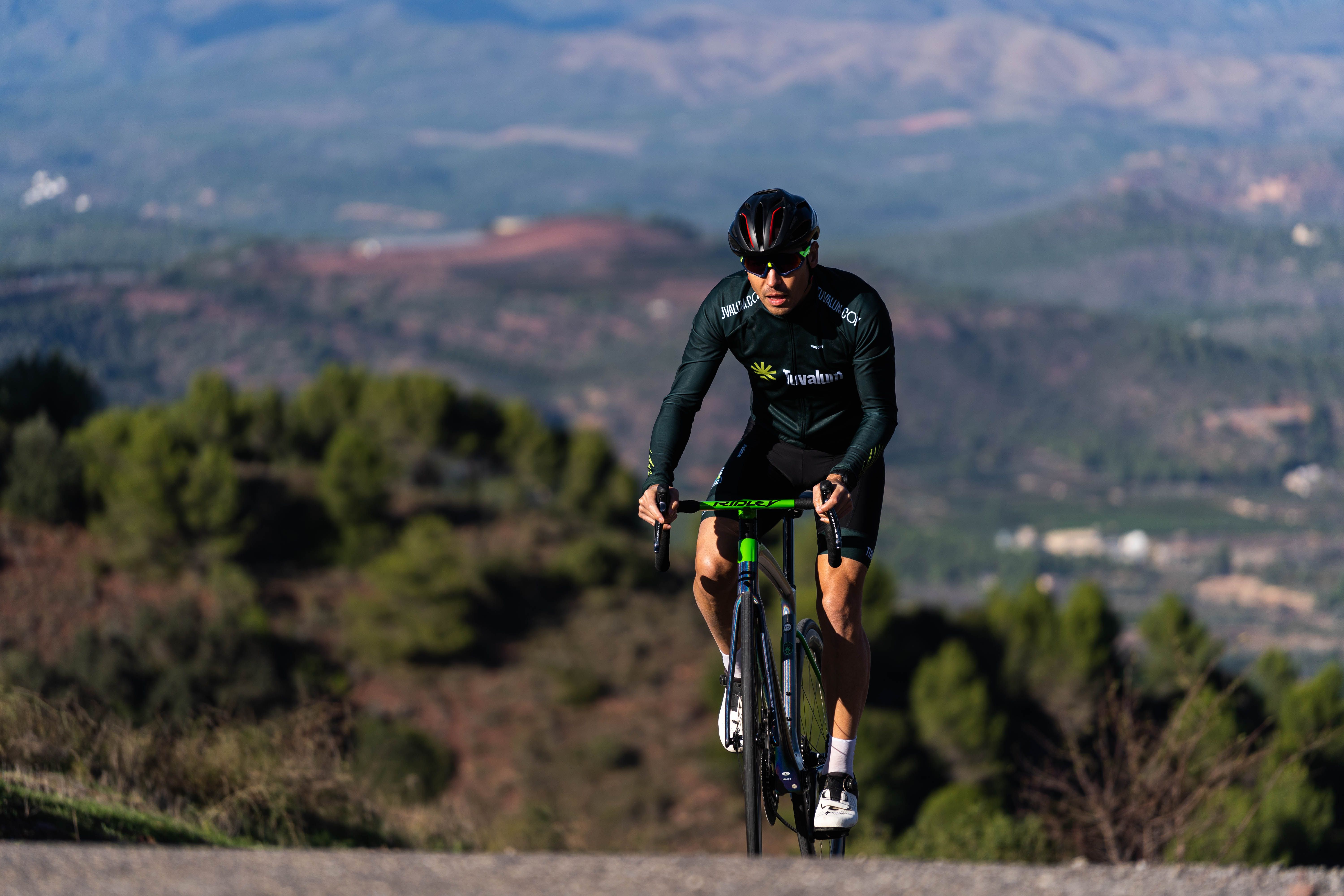 Cyclist Climbing Hill · Free Stock Photo