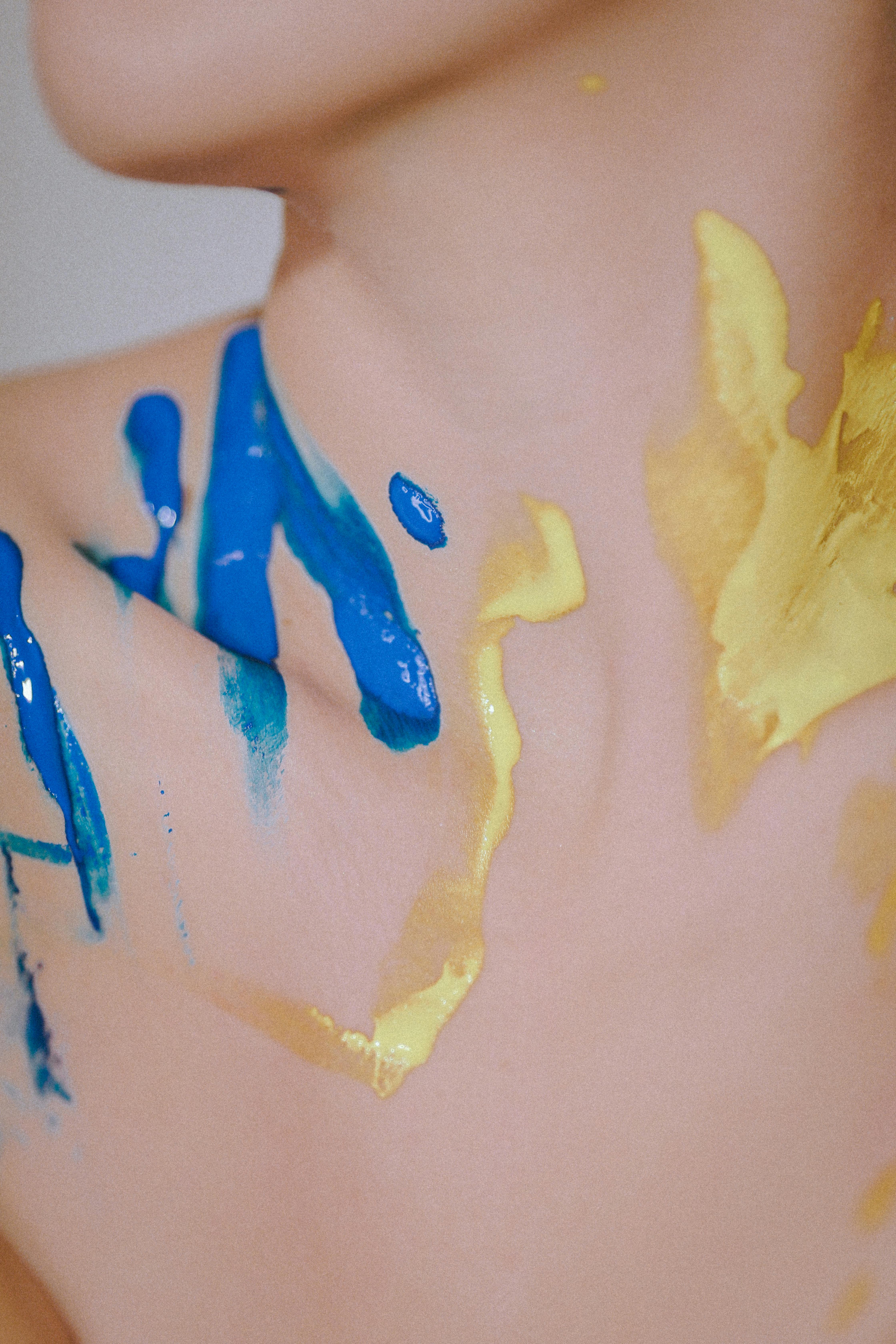 Blue and Yellow Paint on Woman Neck · Free Stock Photo