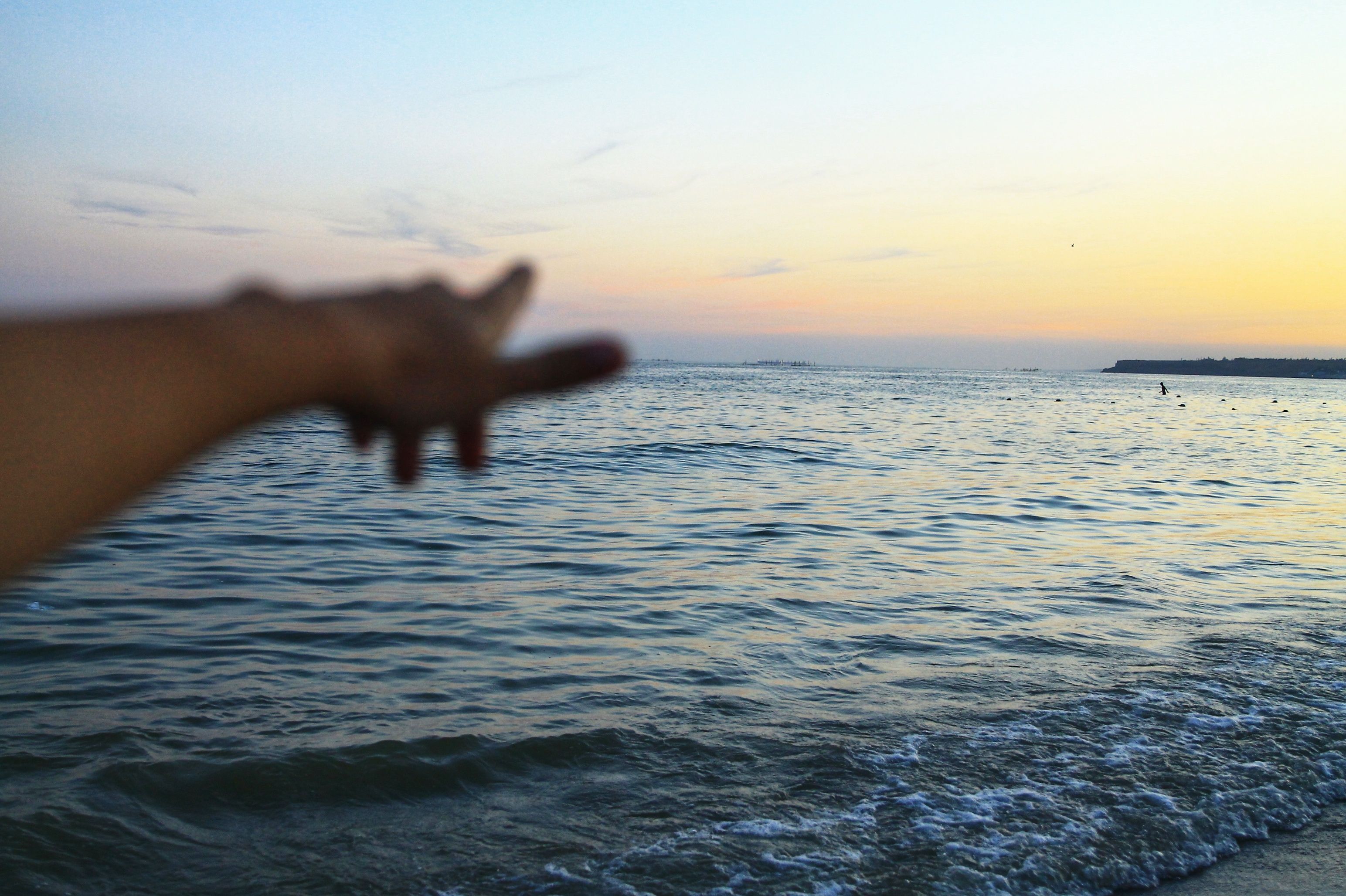 Selective Focus of a Hand Pointing Finger and Sea at Dusk · Free Stock ...