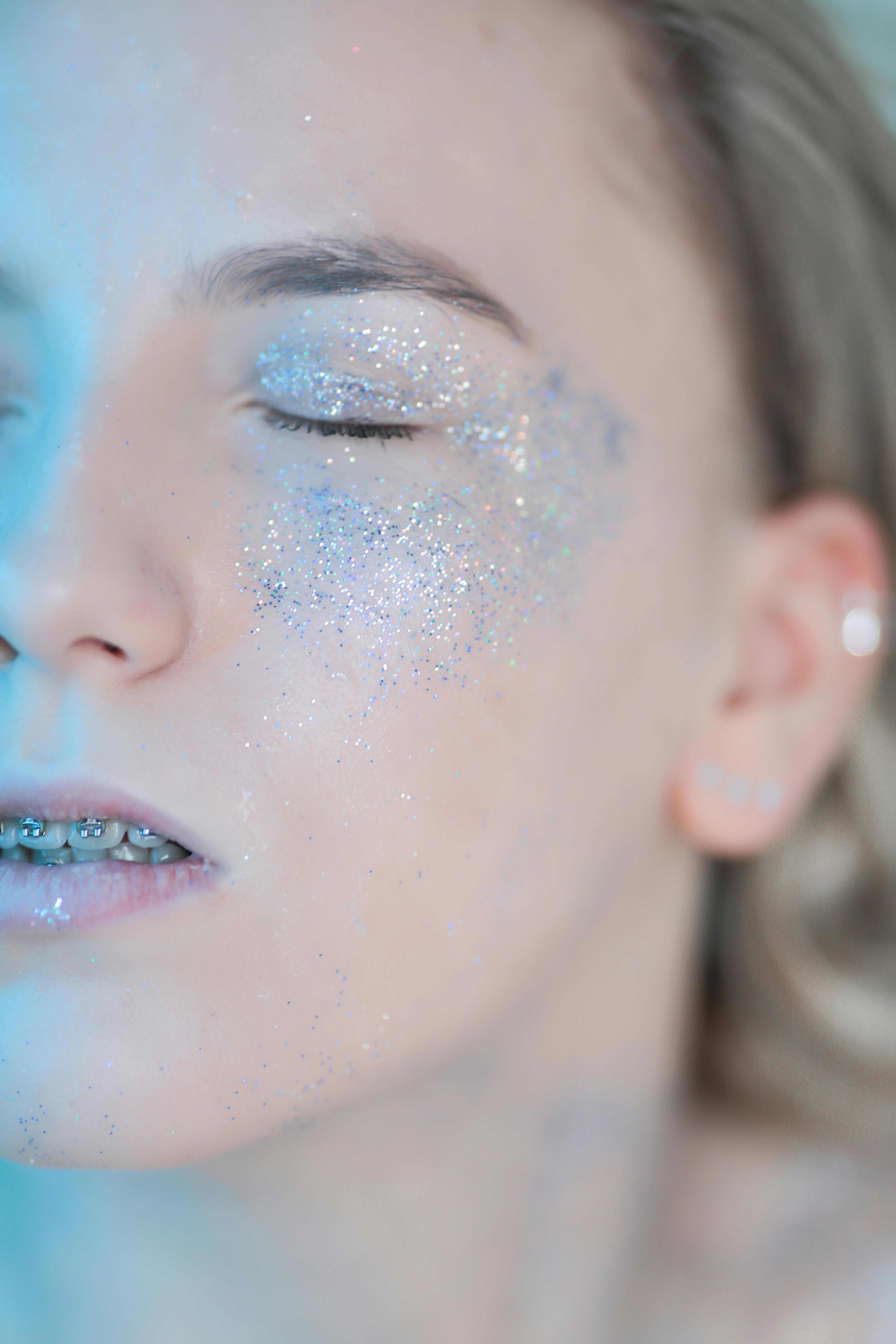 Young Woman with Braces with Glitter on Face · Free Stock Photo
