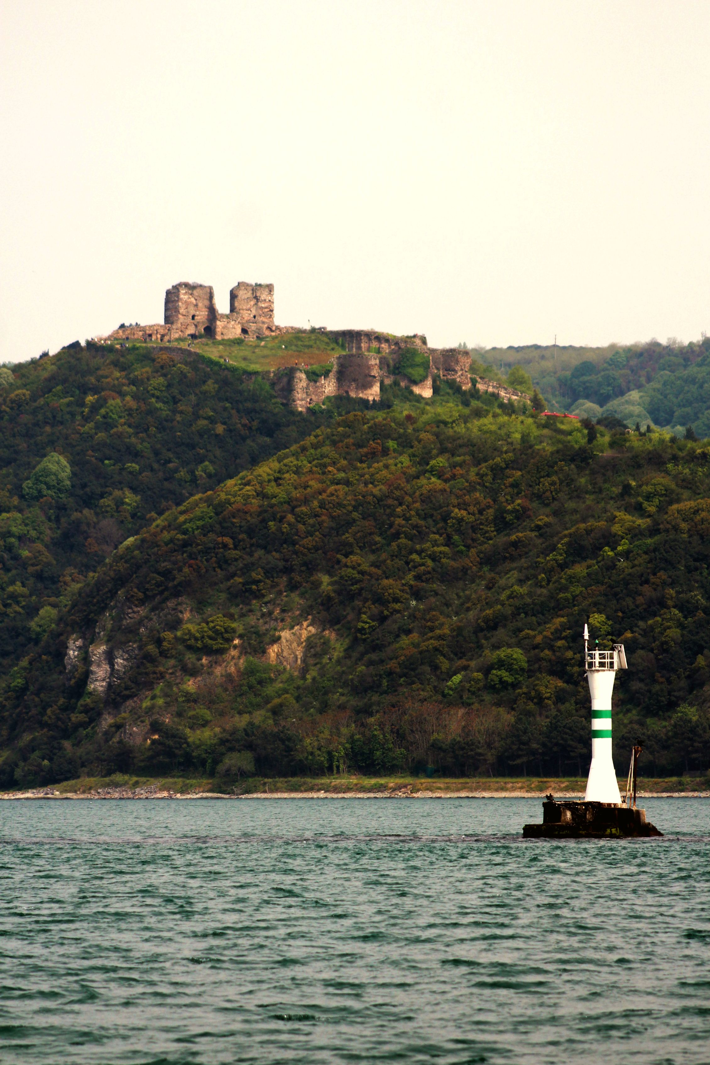Castle Ruins on Hill over Sea Coast with Lighthouse · Free Stock Photo