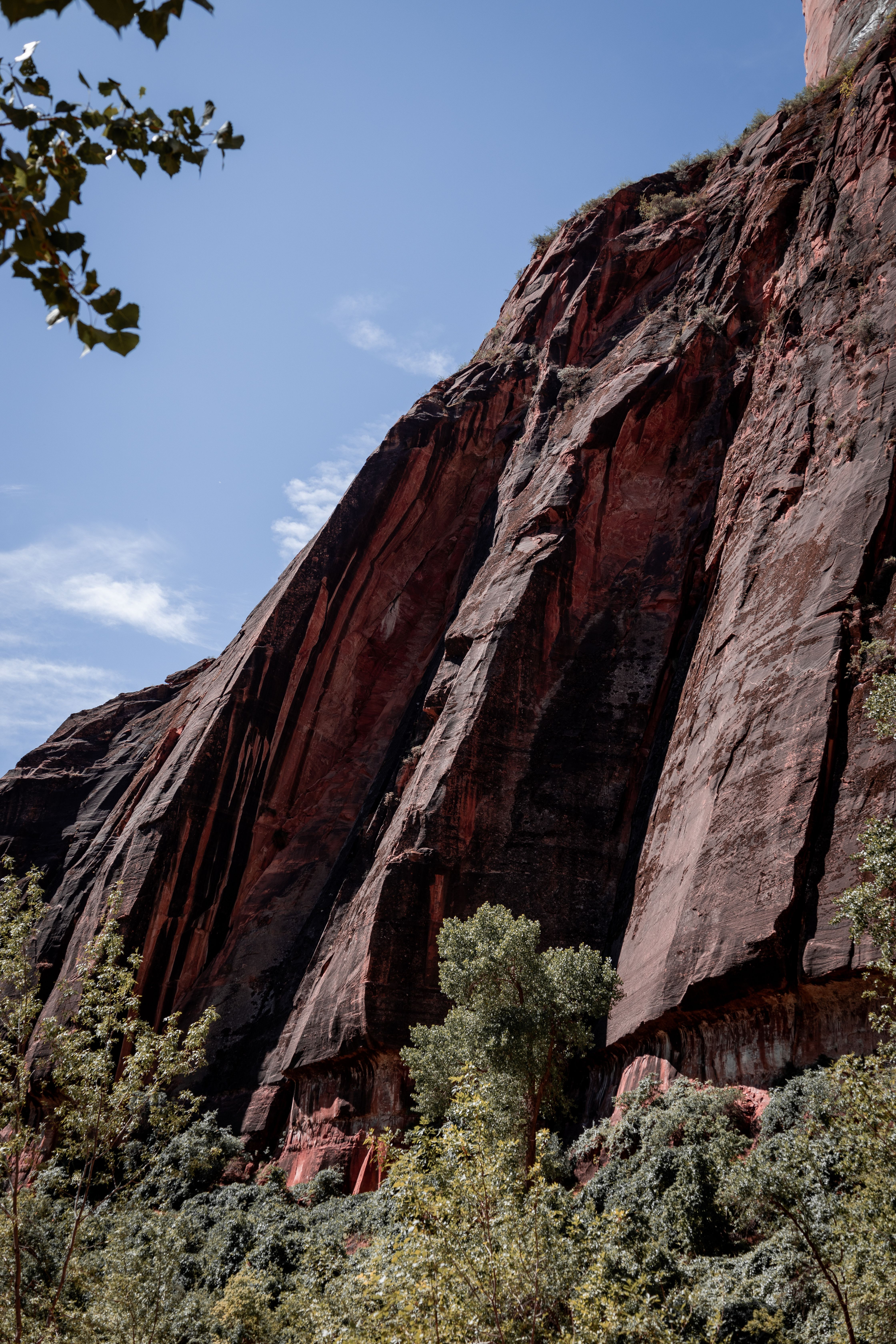 A man is standing on a rock near a cliff · Free Stock Photo