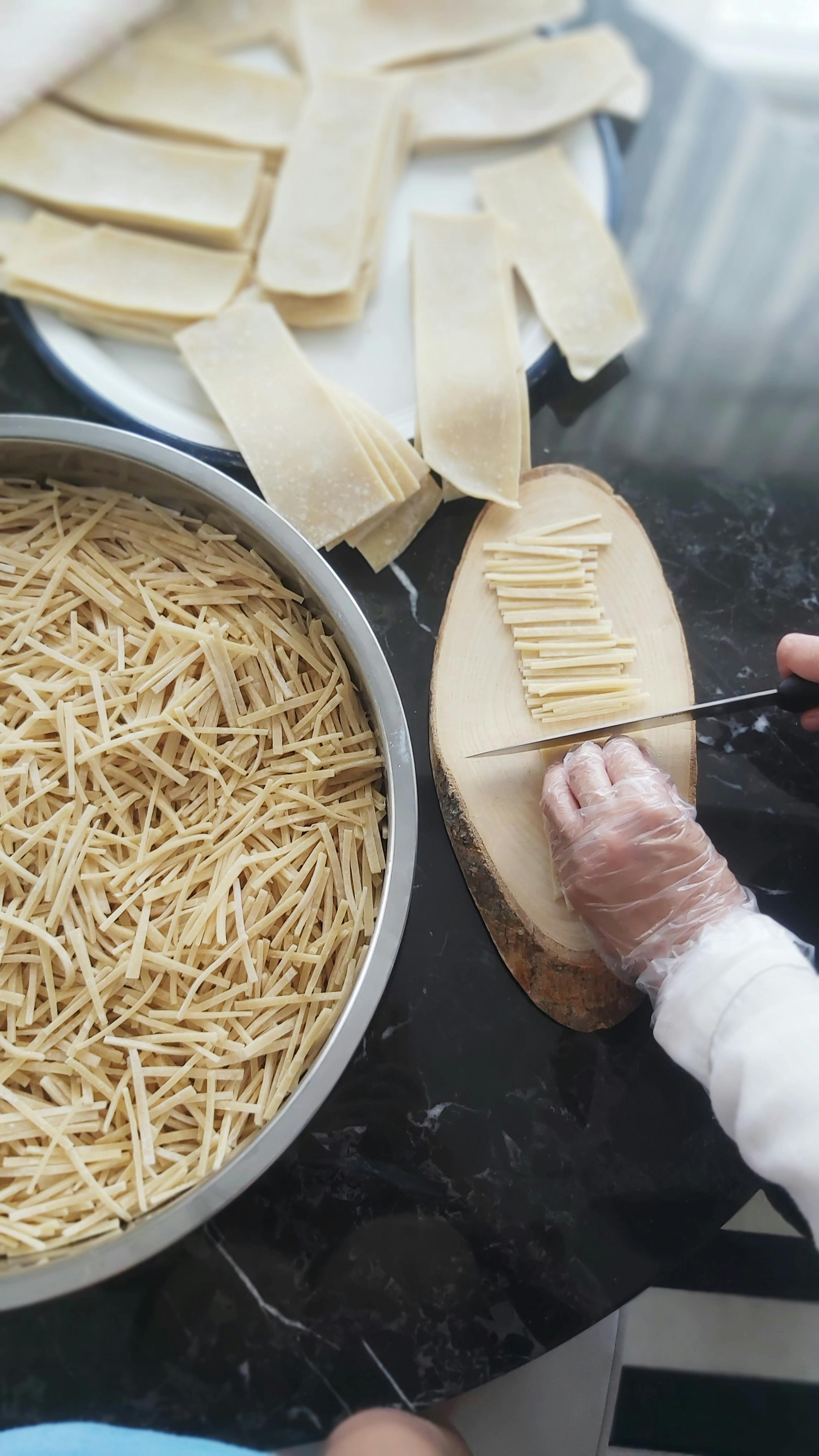 Hand in Glove Cutting and Preparing Pasta · Free Stock Photo