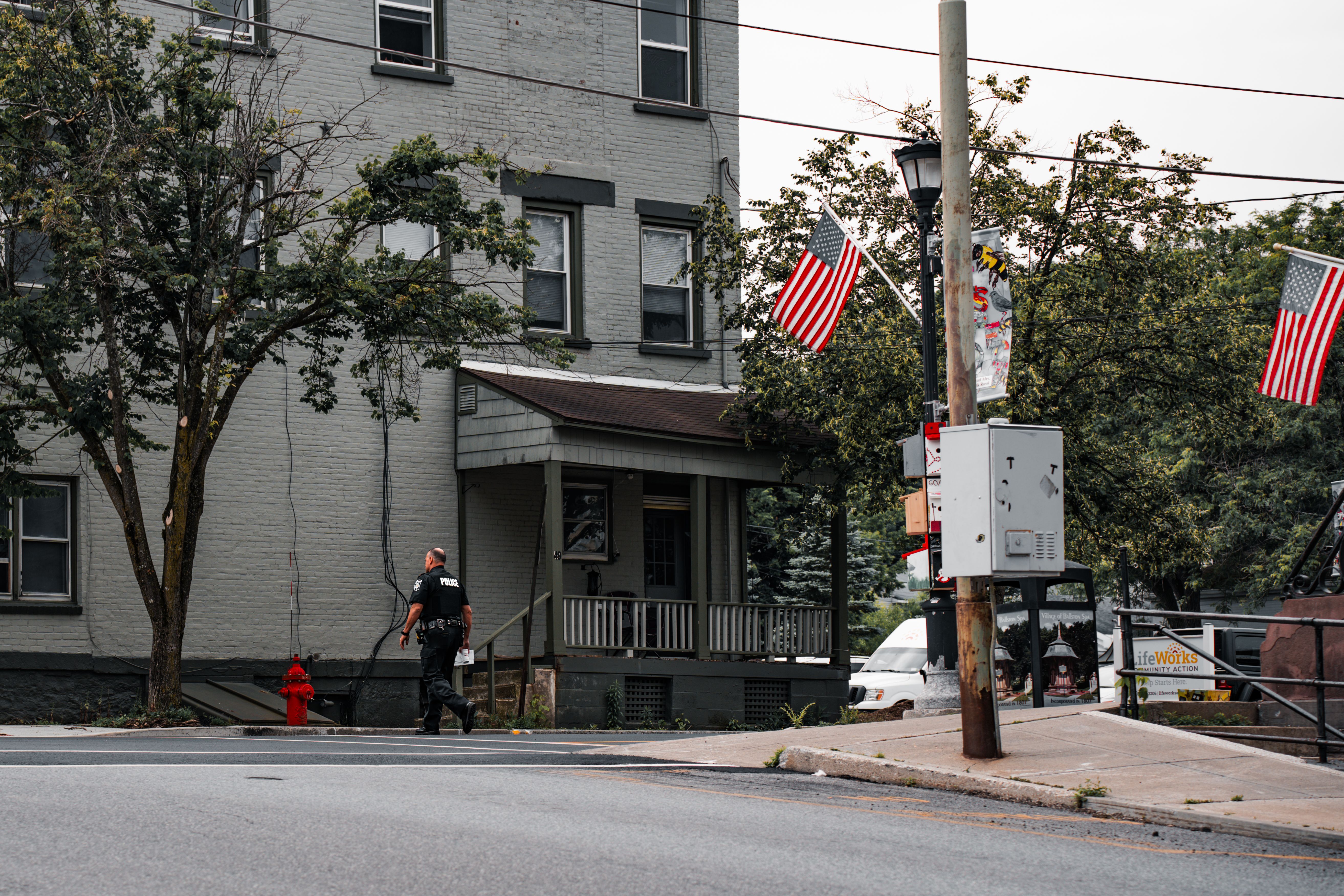 A Police Officer Crossing the Street in a Town Decorated with American ...