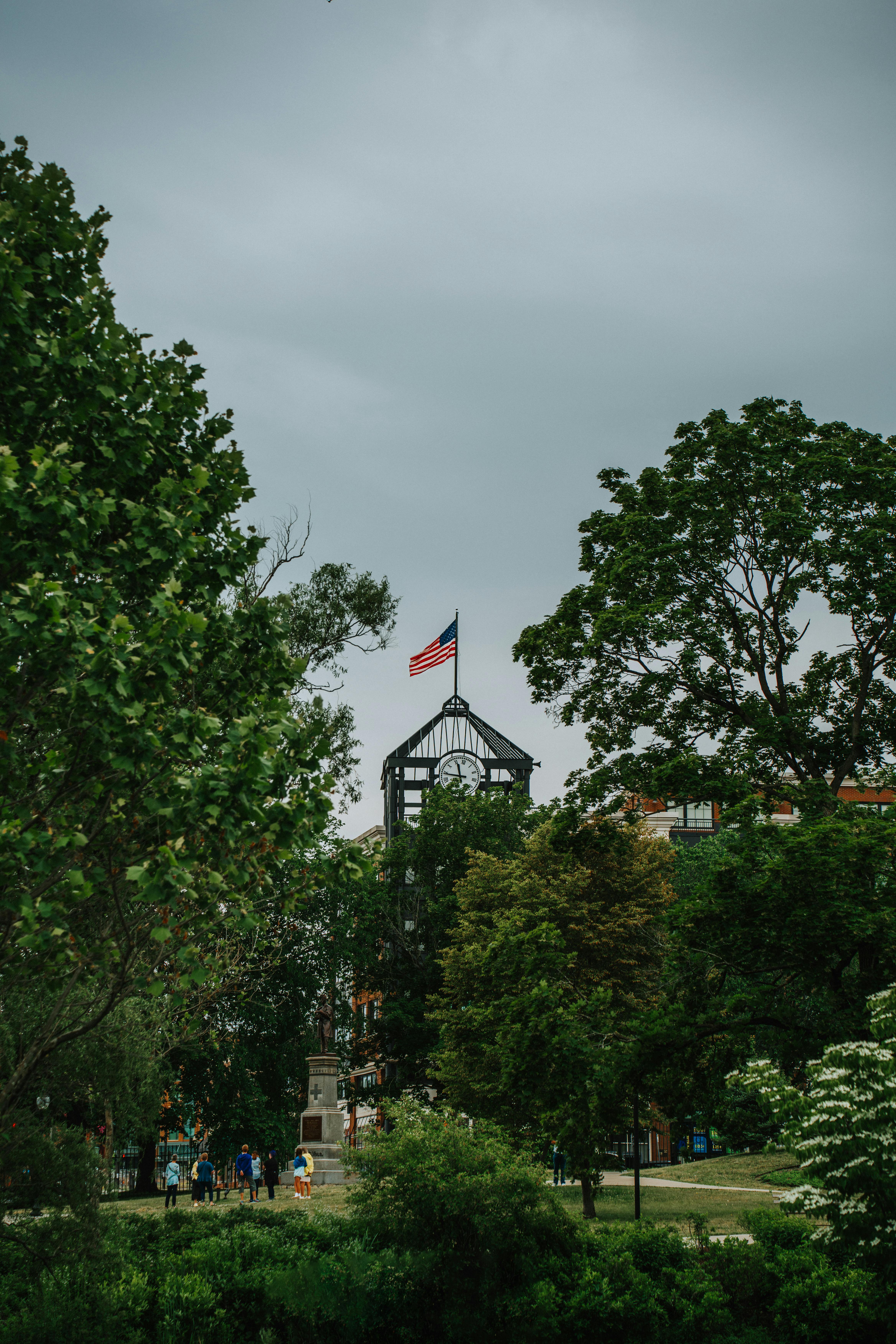 American Flag behind Trees in Park · Free Stock Photo