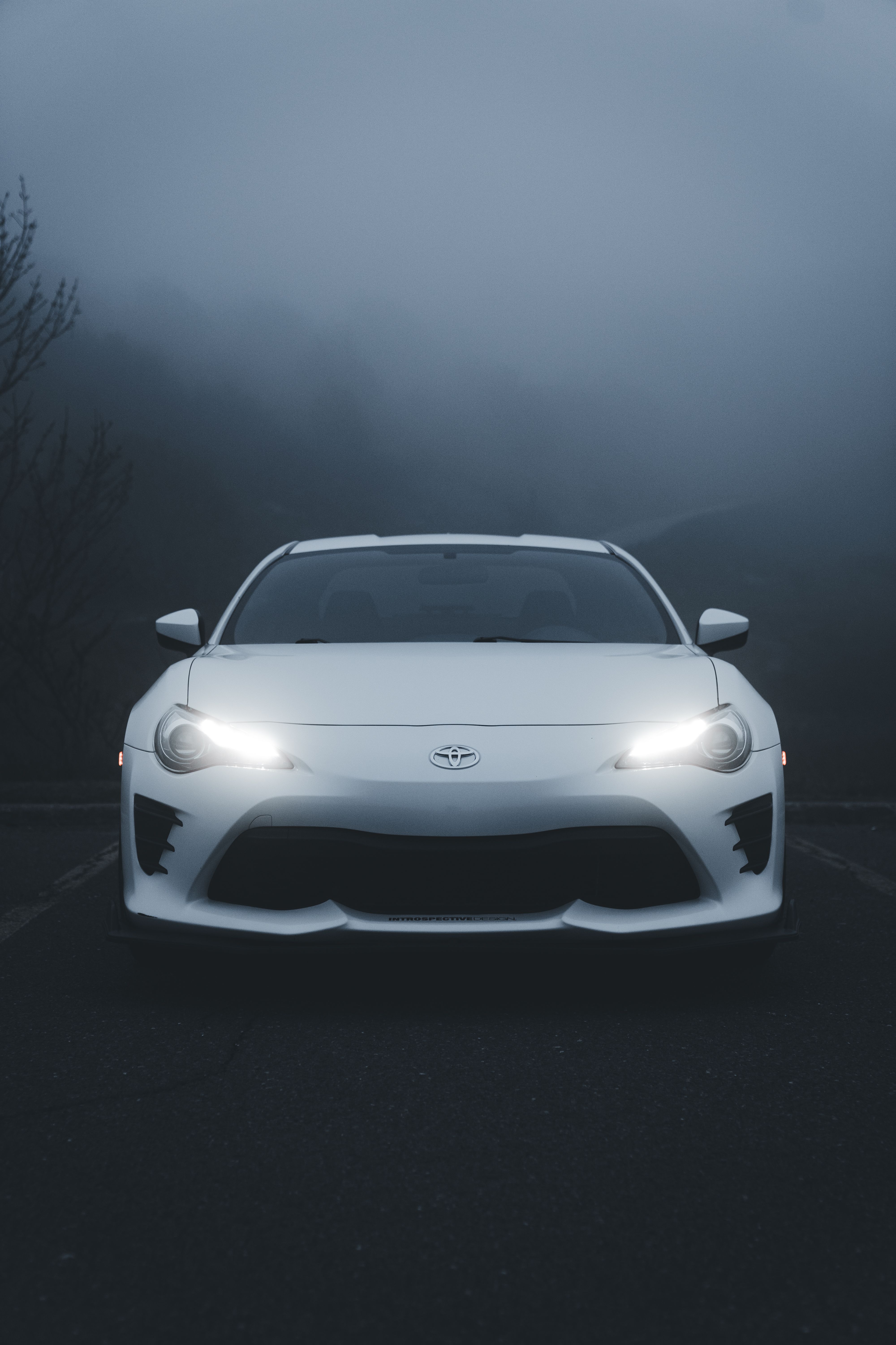 White Toyota with Illuminated Headlights · Free Stock Photo