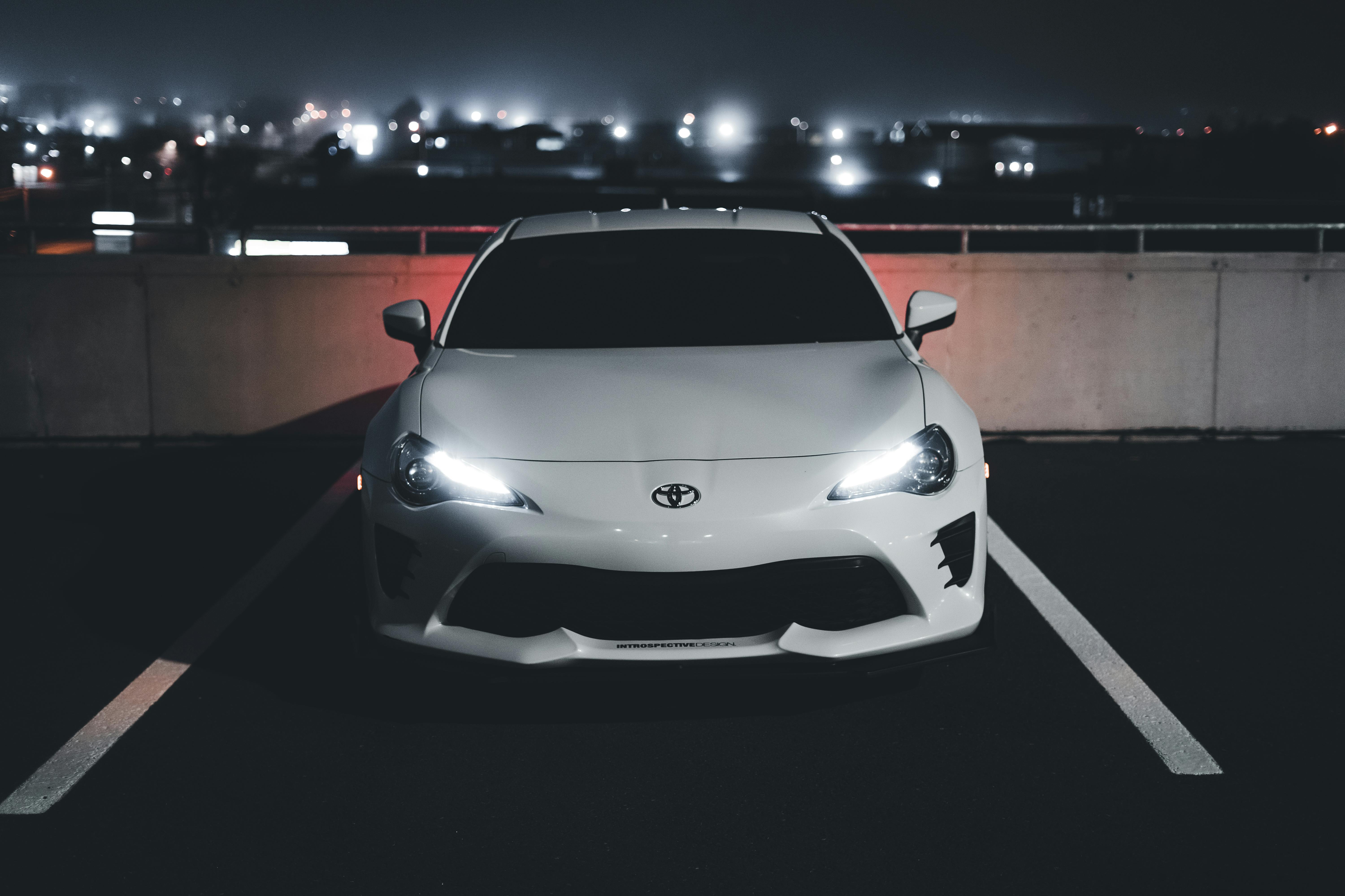 Car with Illuminated Headlights · Free Stock Photo