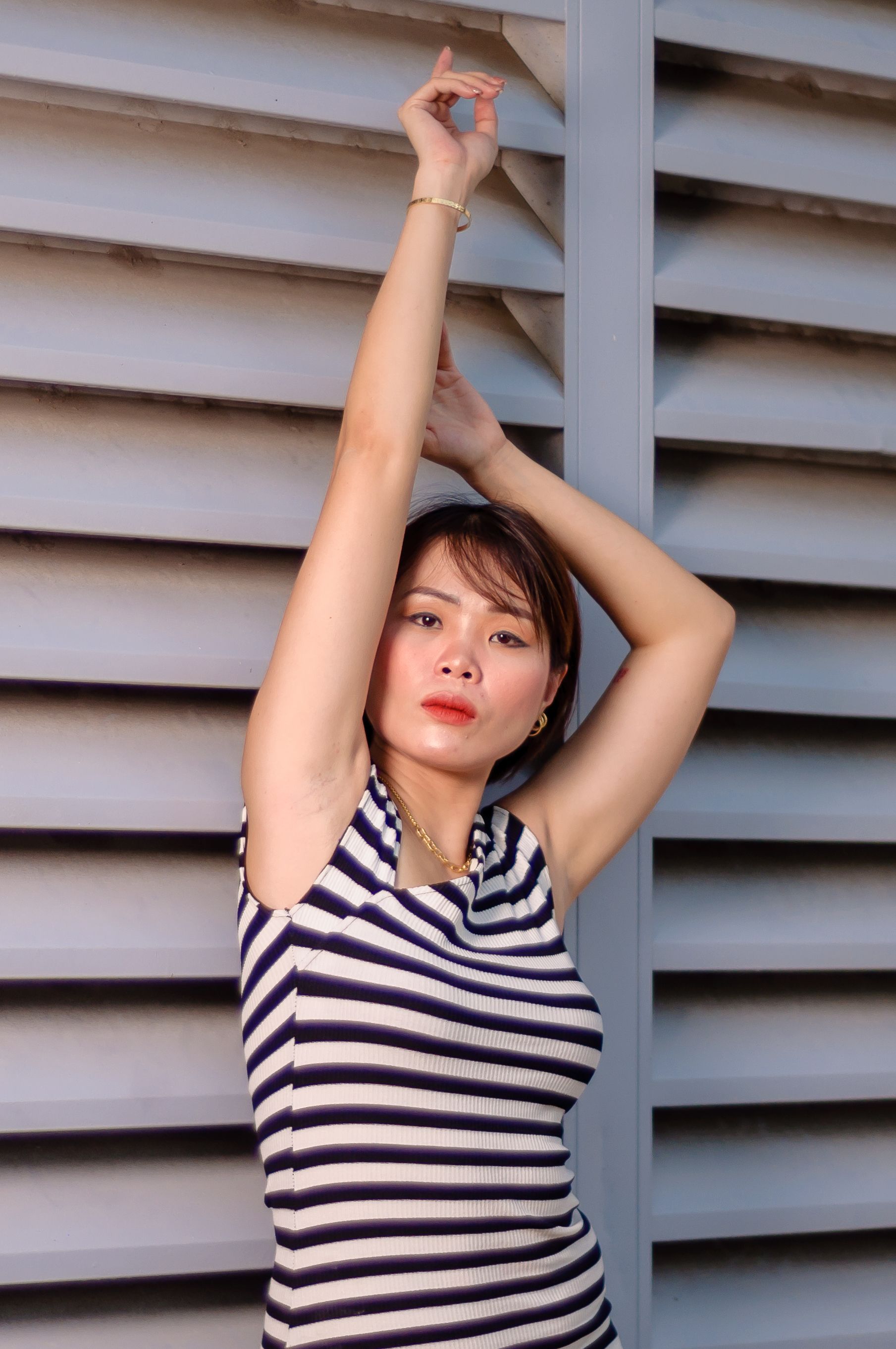 Woman Posing with Arms Raised · Free Stock Photo