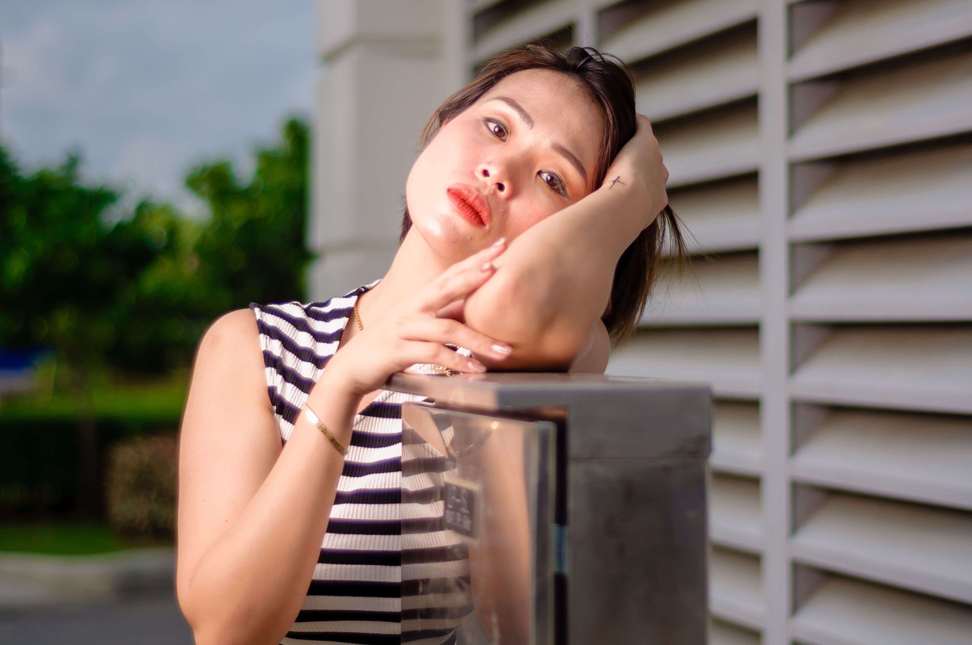 Woman Leaning on Box and Posing · Free Stock Photo