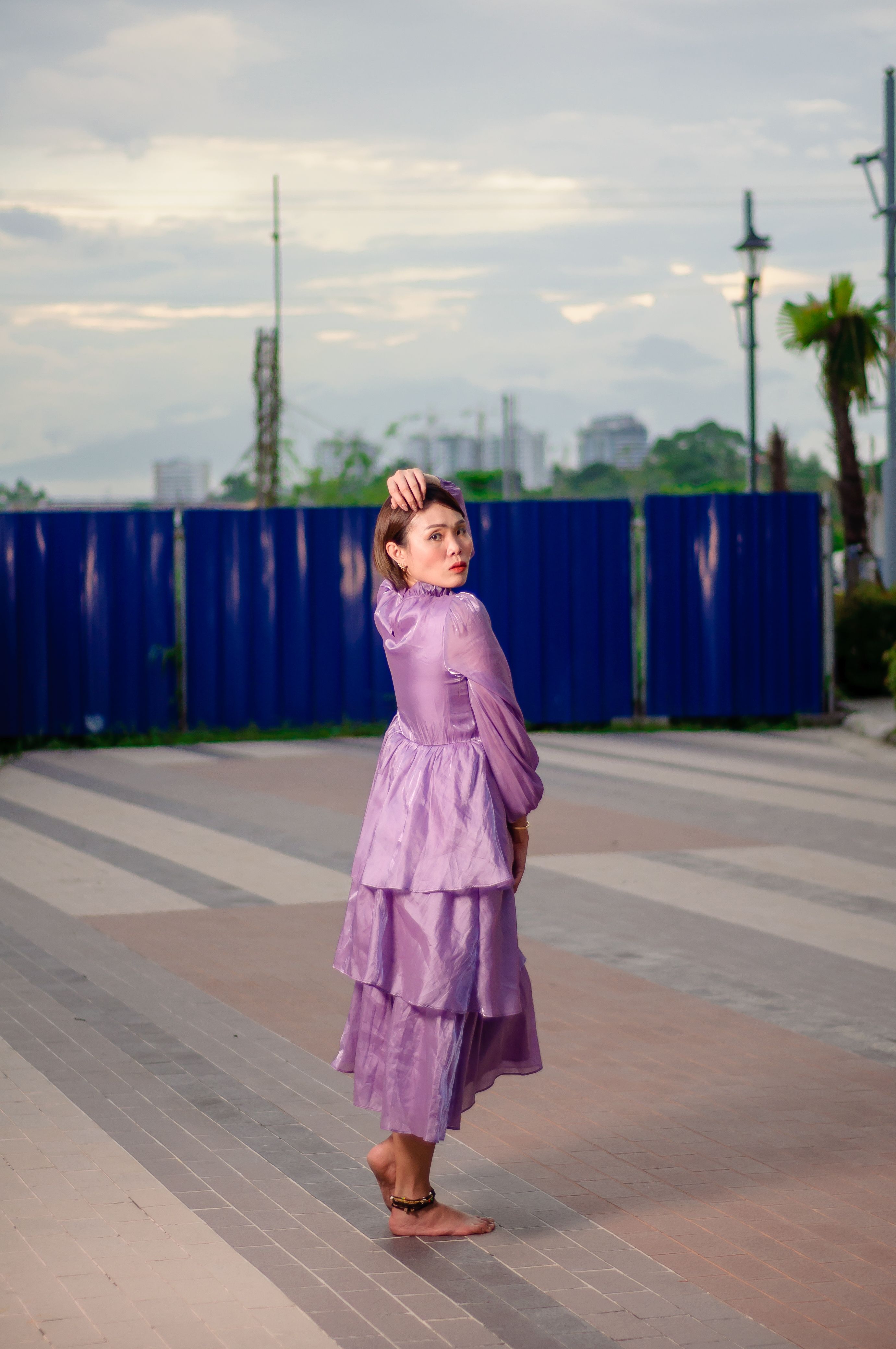 Barefoot Woman in Violet Dress Standing on One Foot · Free Stock Photo