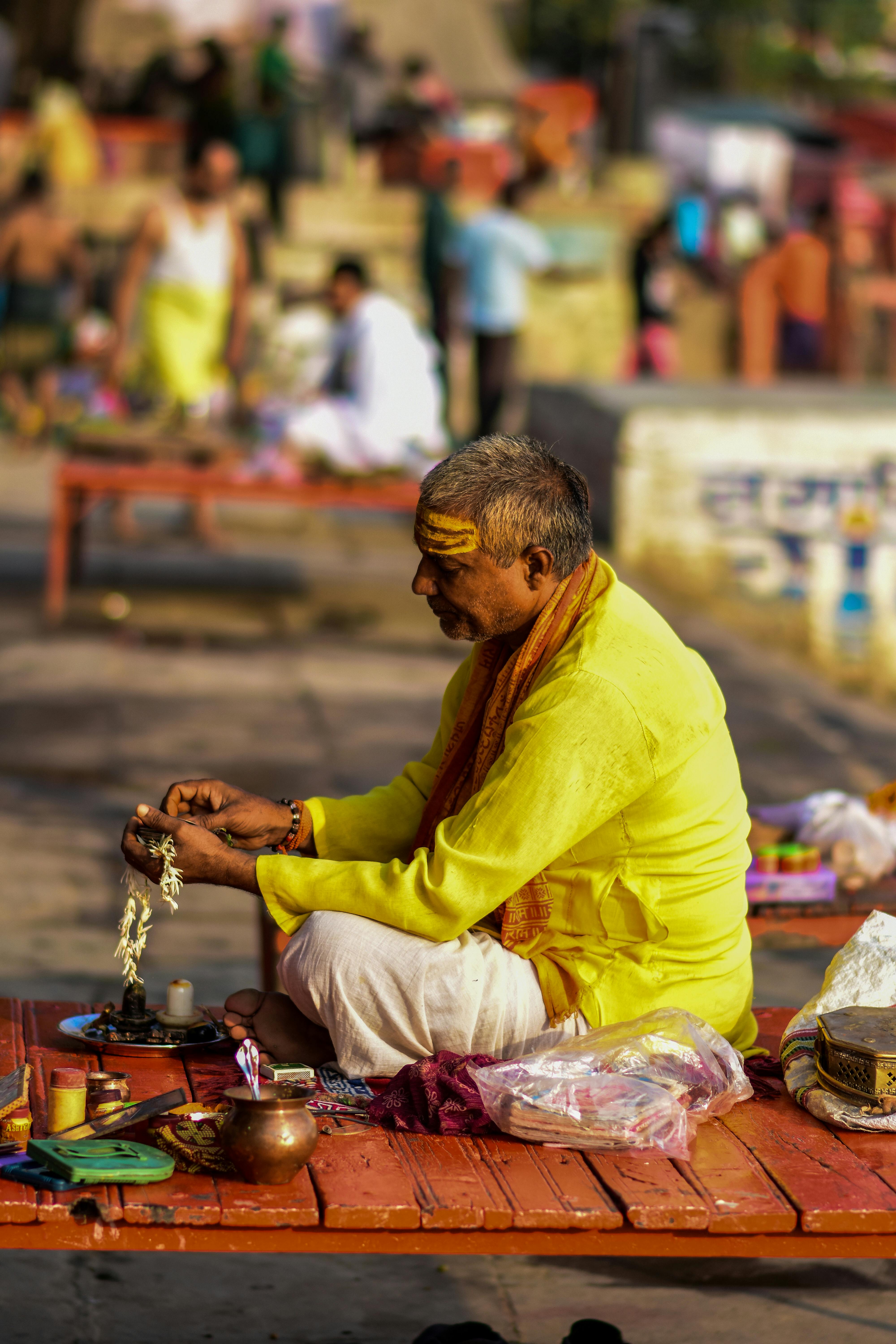 Sadhu Surrounded by Devotional Items · Free Stock Photo