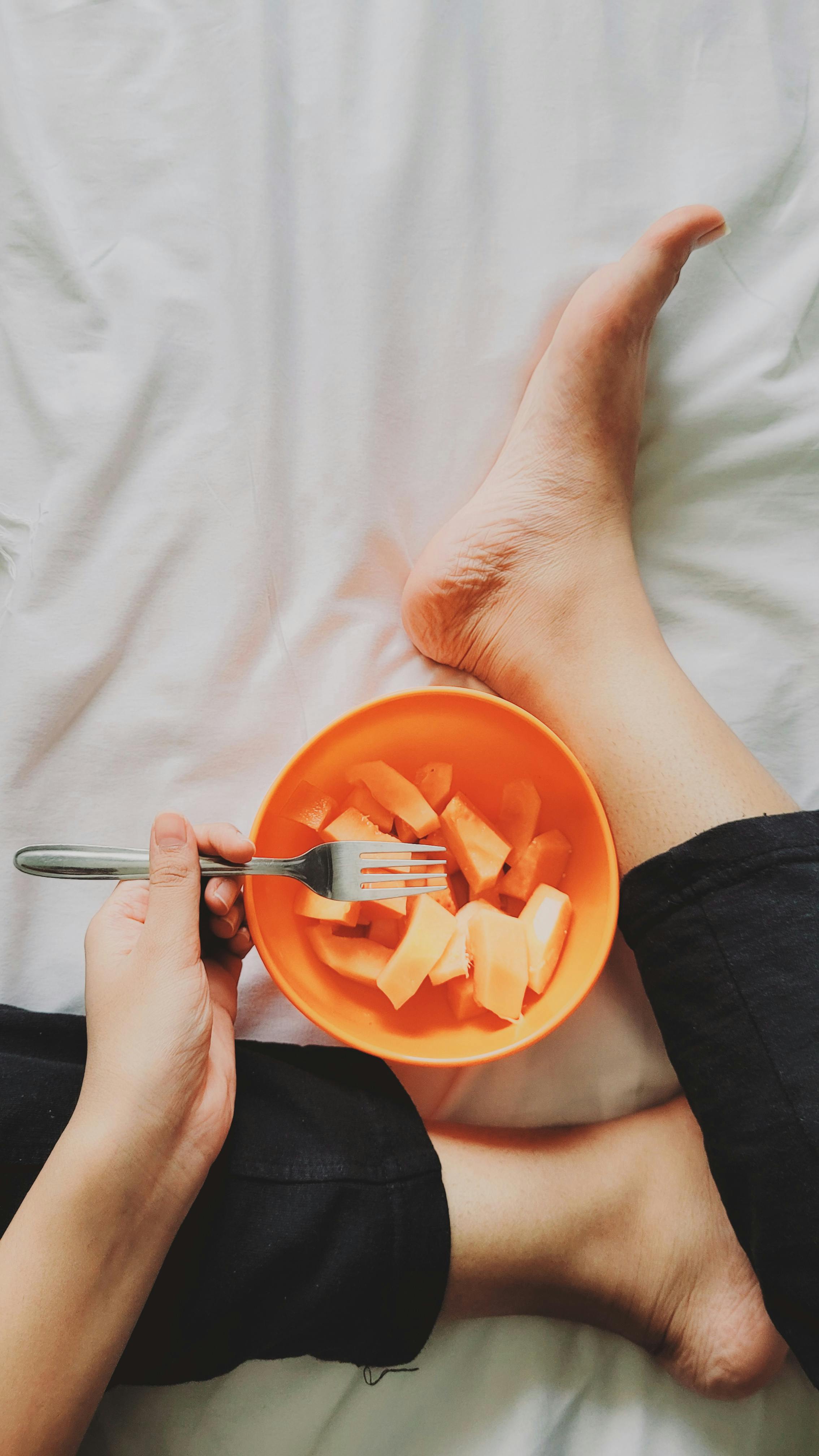 Woman Eating a Snack in Bed · Free Stock Photo