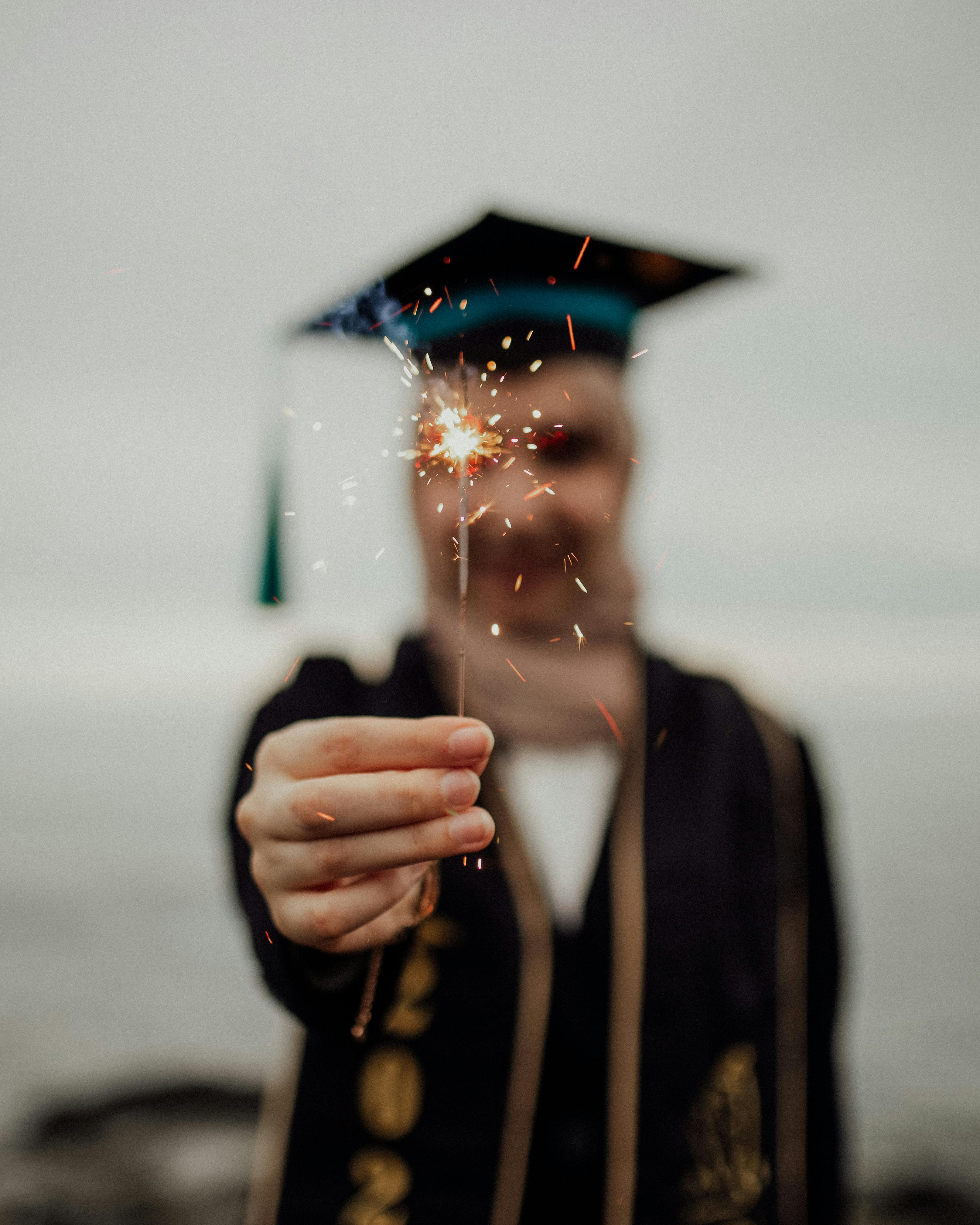 Sparkler in Graduate Hand · Free Stock Photo