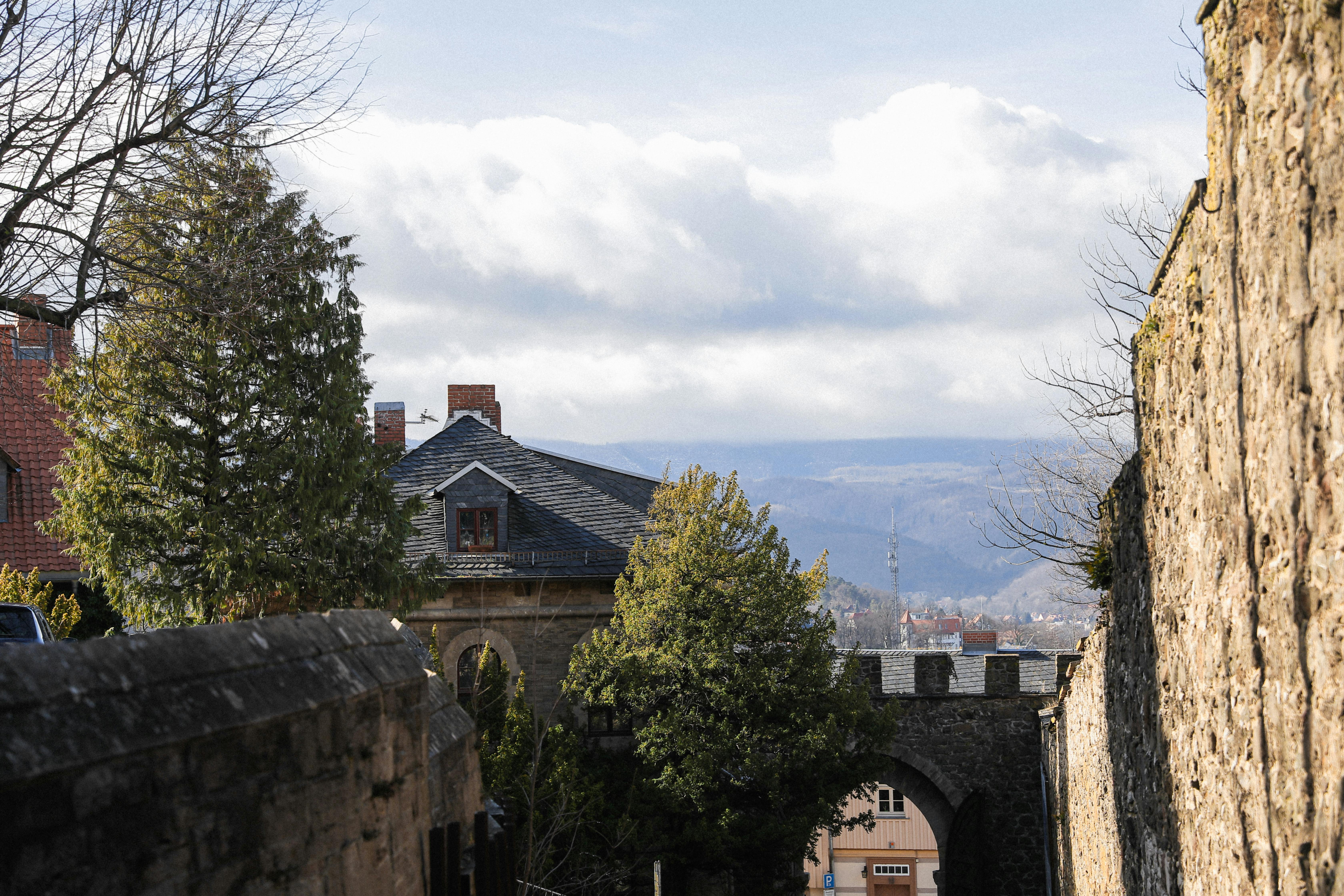 View of a Walkway Downhill under a Gate of a Castle · Free Stock Photo