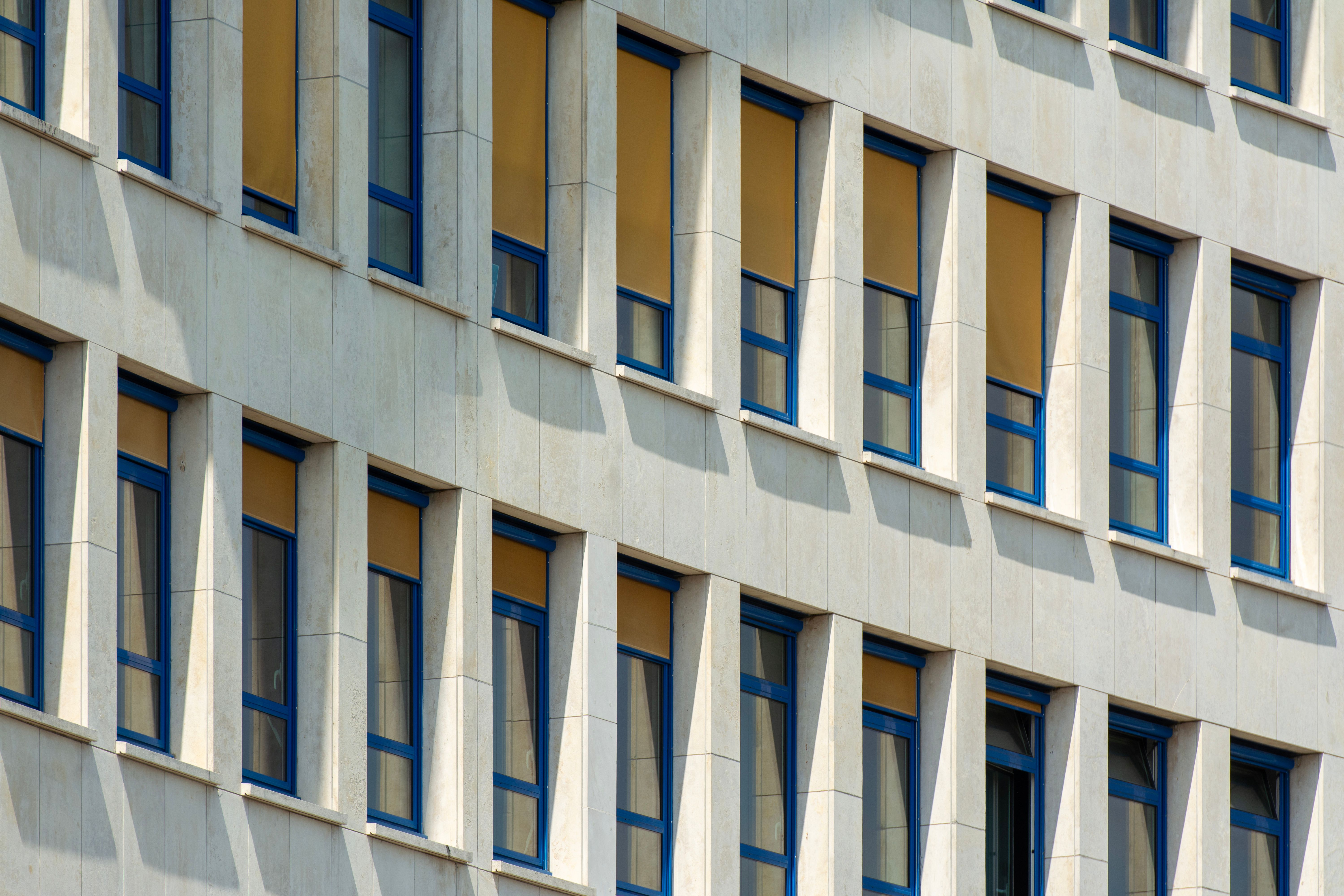 Windows on Orange Building Wall · Free Stock Photo