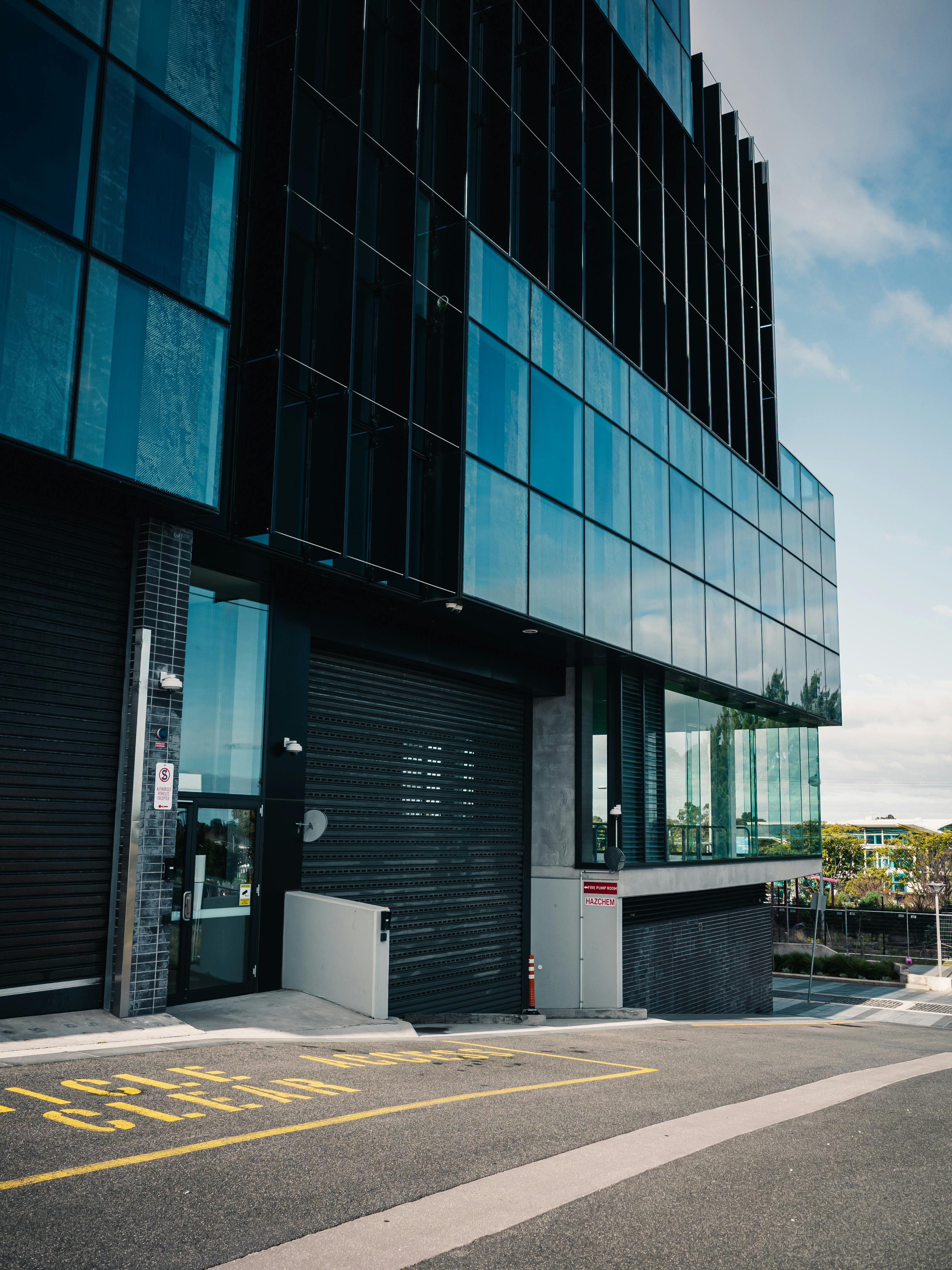 Modern Glass Building on Road in City · Free Stock Photo