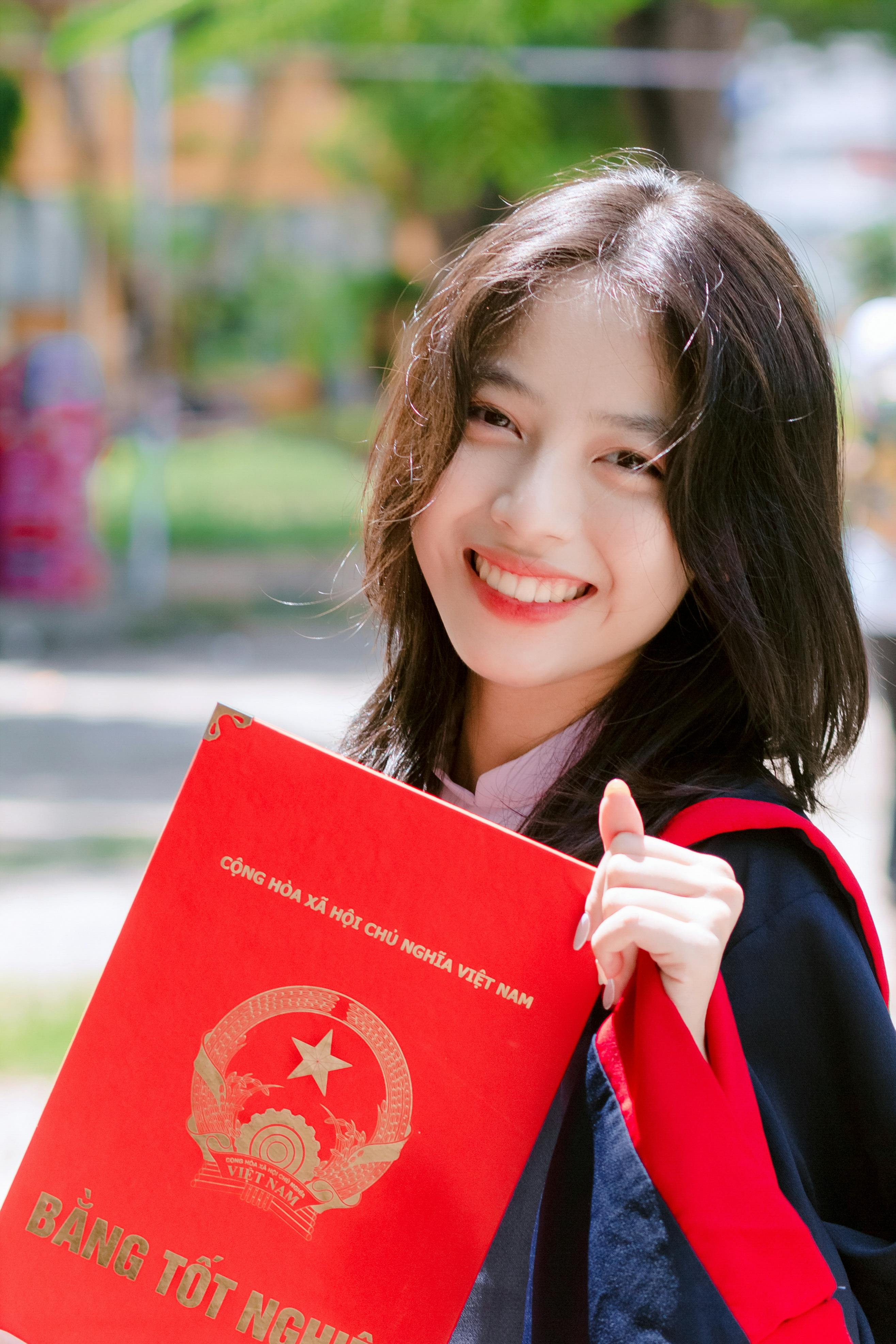 Smiling Graduate with Diploma · Free Stock Photo