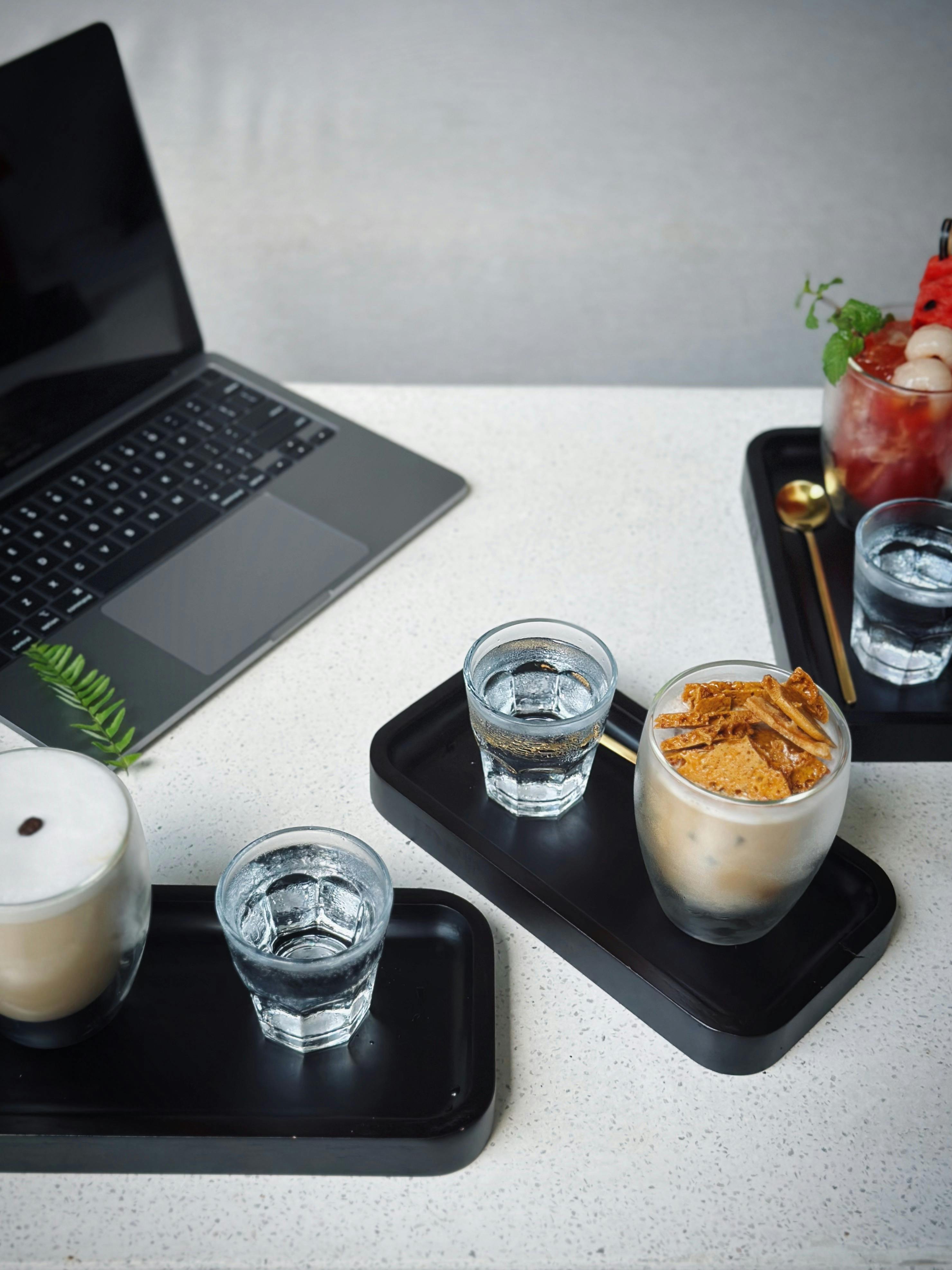 Macbook Pro Besides Clear Glass Mug · Free Stock Photo