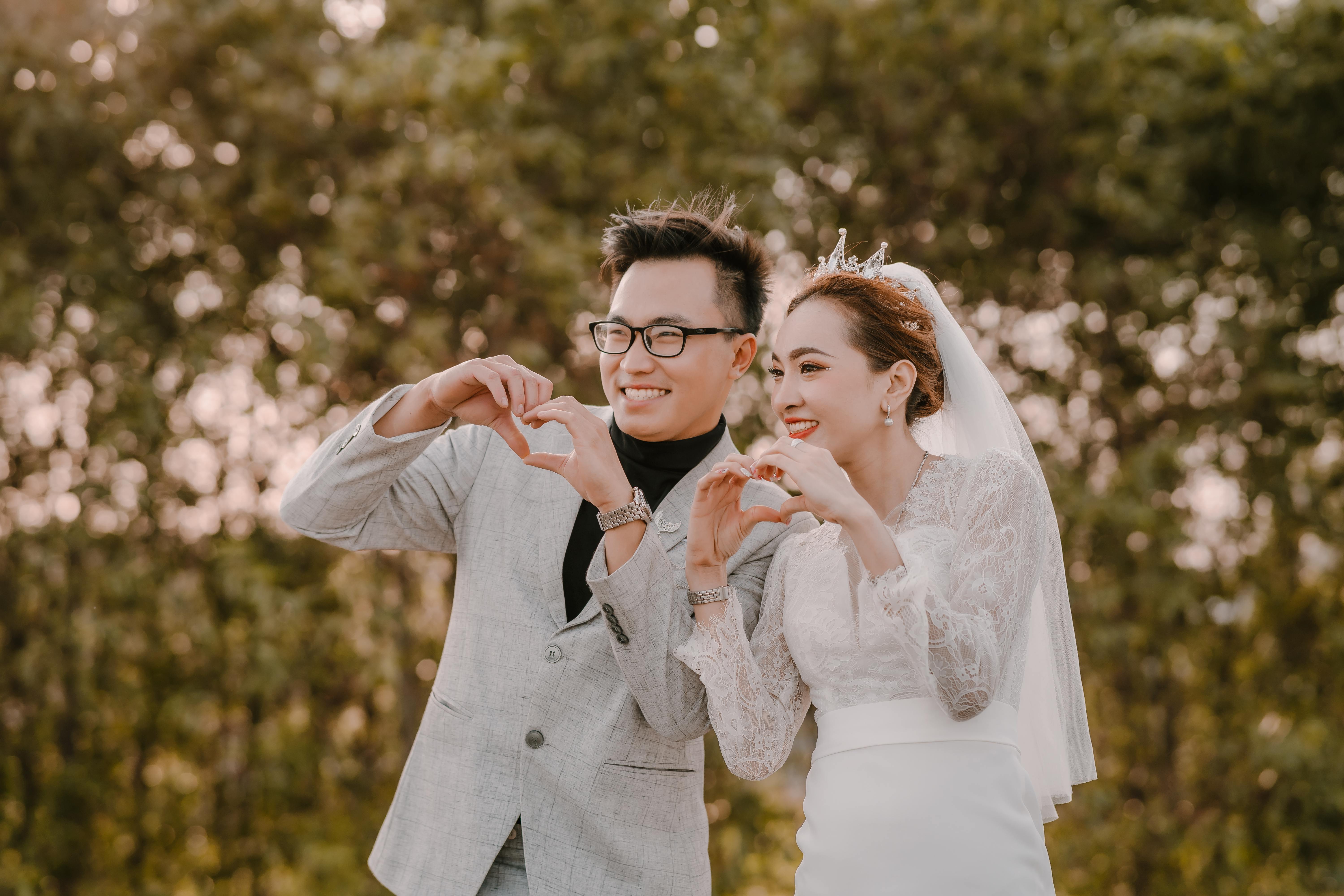 Bride and Groom Making a Heart Shape with Their Hands · Free Stock Photo
