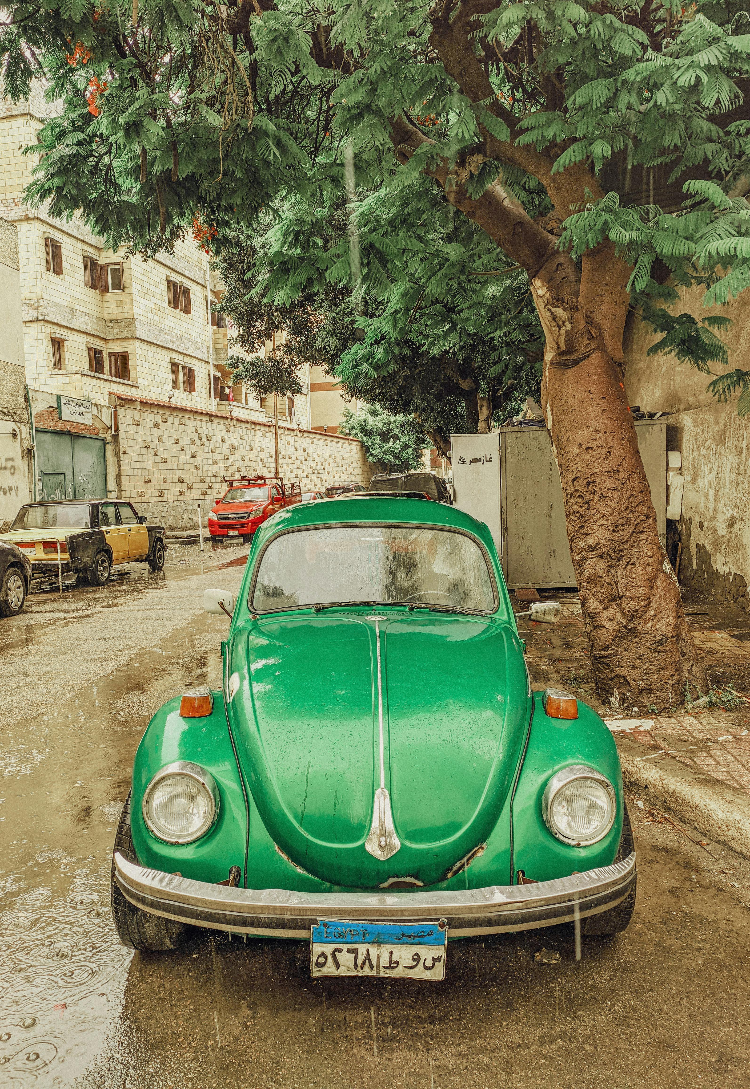 Retro Car on Old Town Street near Tree · Free Stock Photo