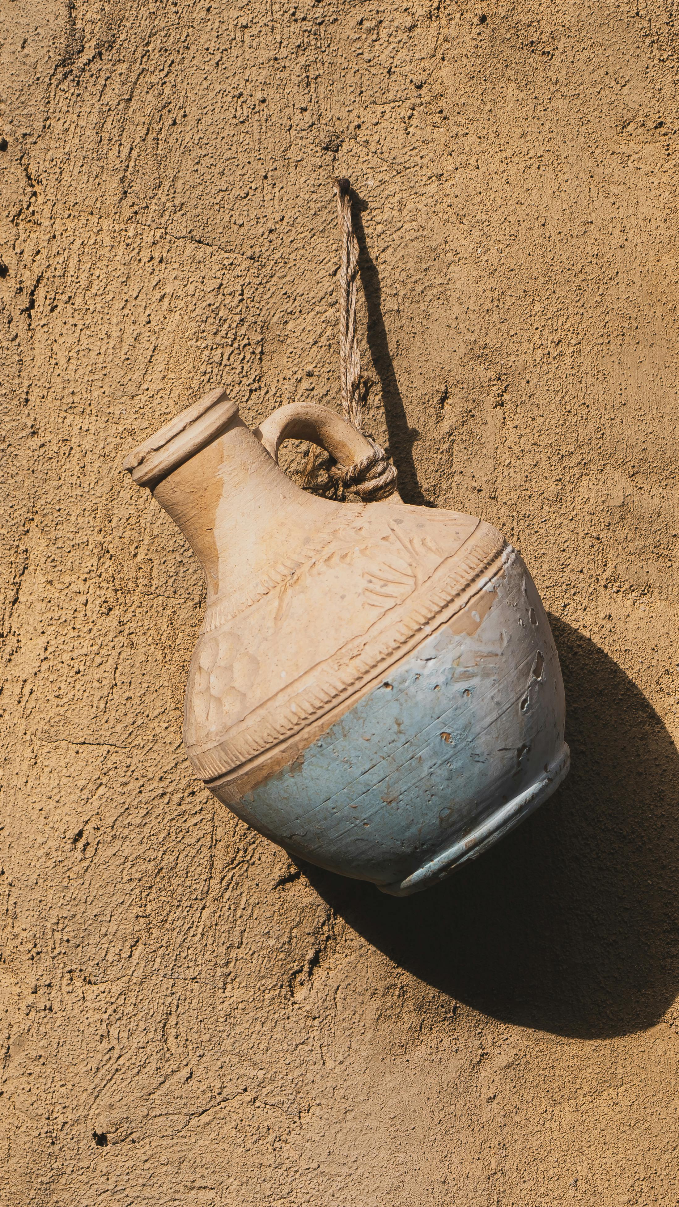 Old Pottery Jug Hanging on Rope on Wall · Free Stock Photo