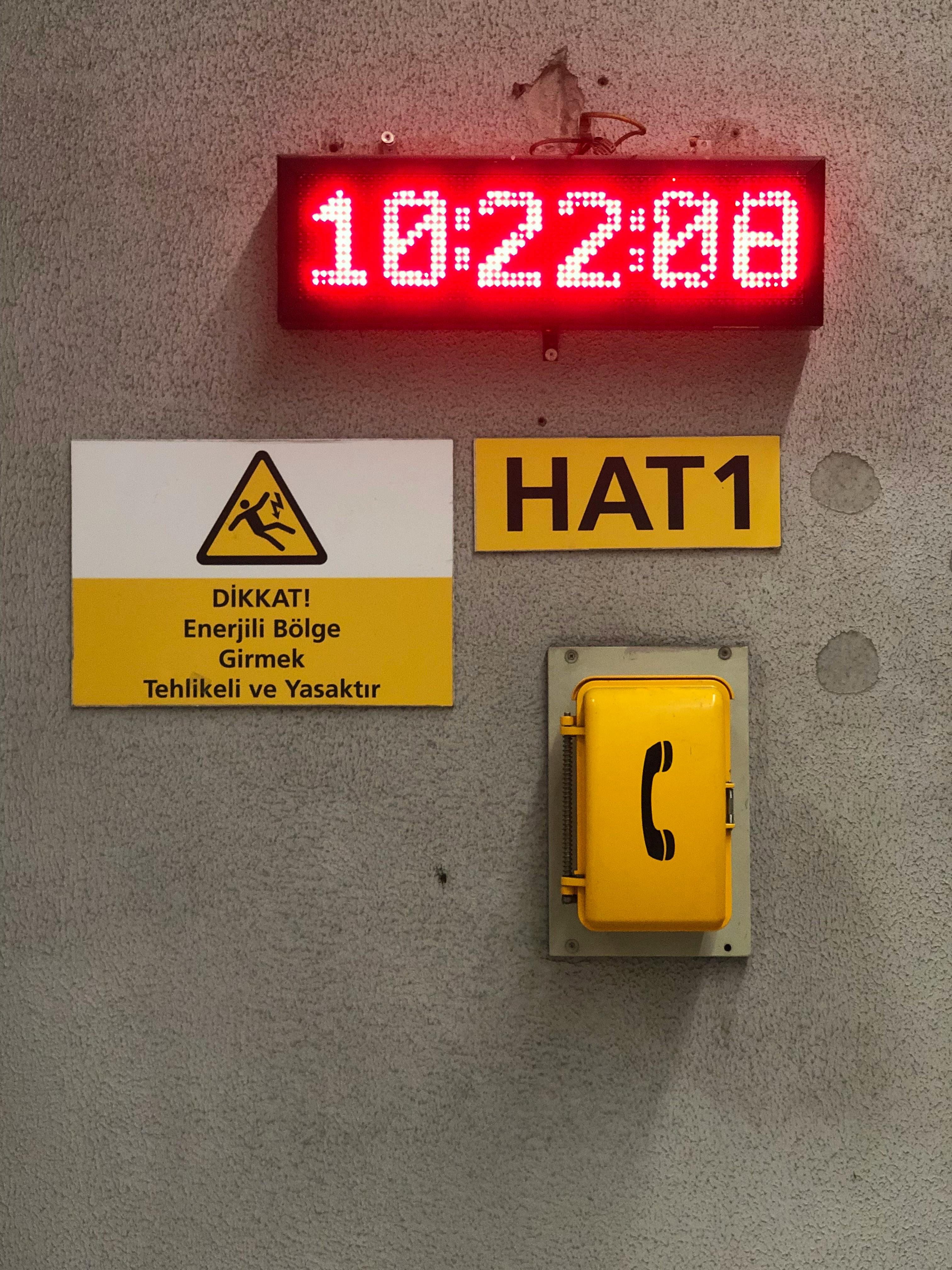 Emergency Phone and a Digital Clock on the Wall · Free Stock Photo