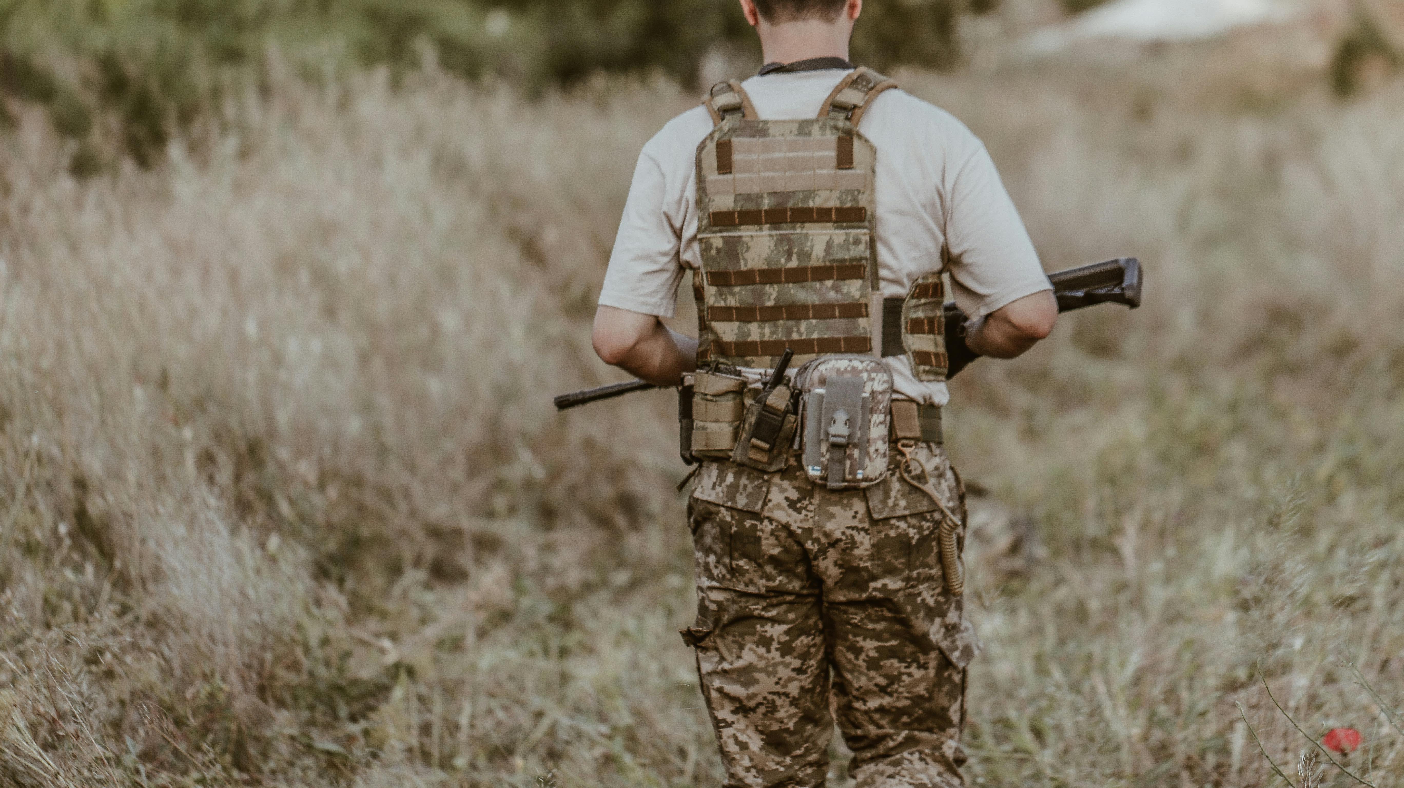 Two Men in Army Uniforms With Guns · Free Stock Photo