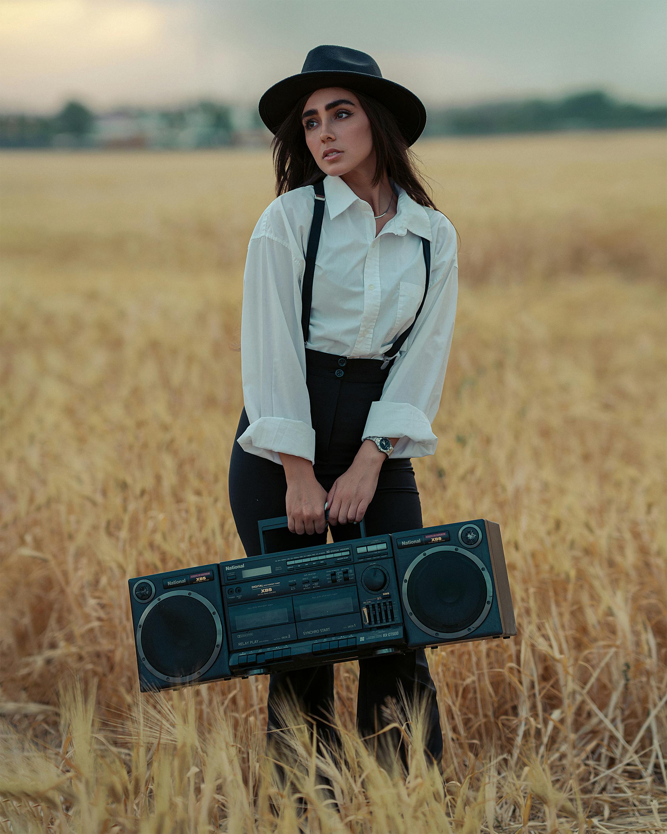 Model Posing with Boom Box in Field · Free Stock Photo