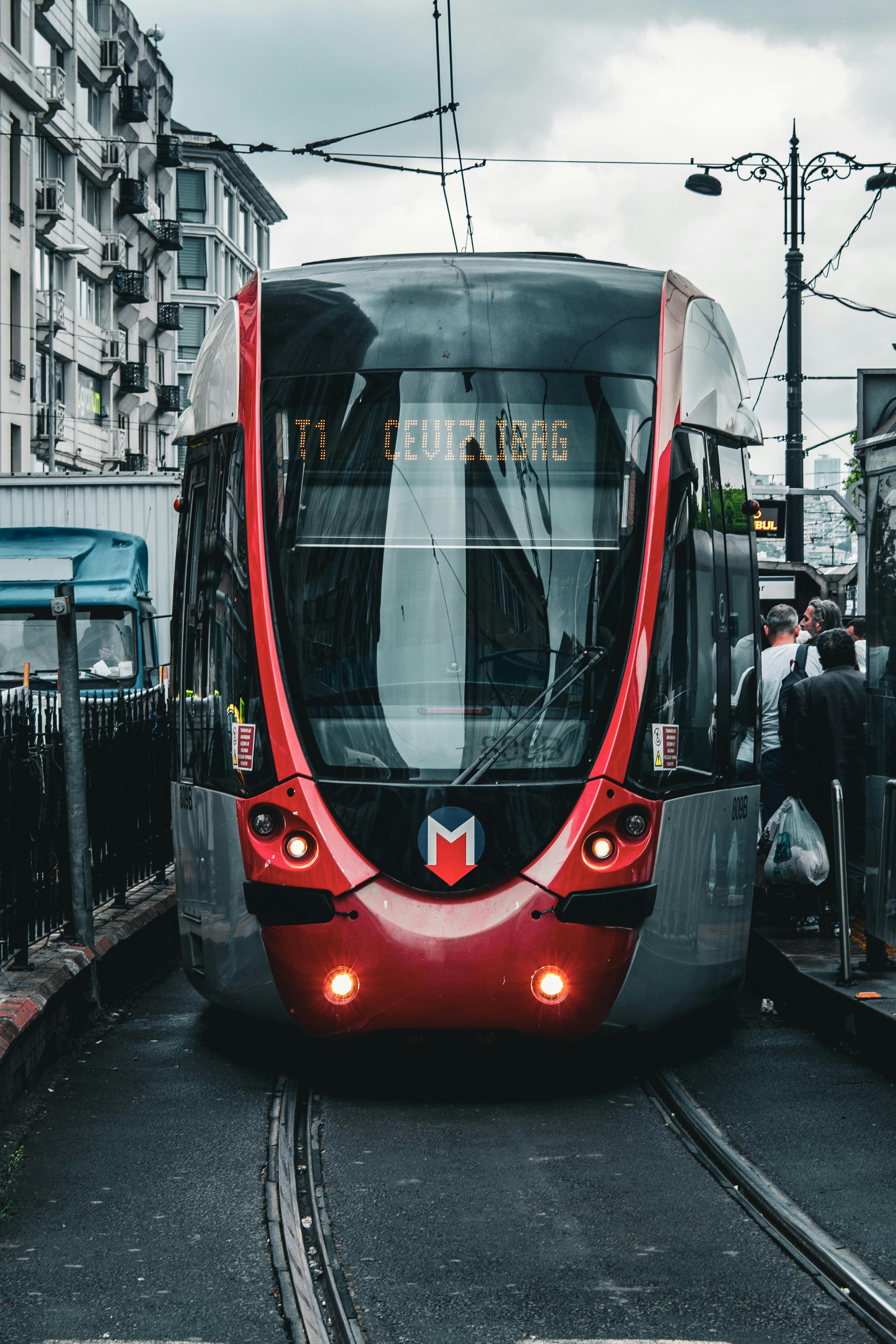 Red Tram Parked Beside a Building · Free Stock Photo