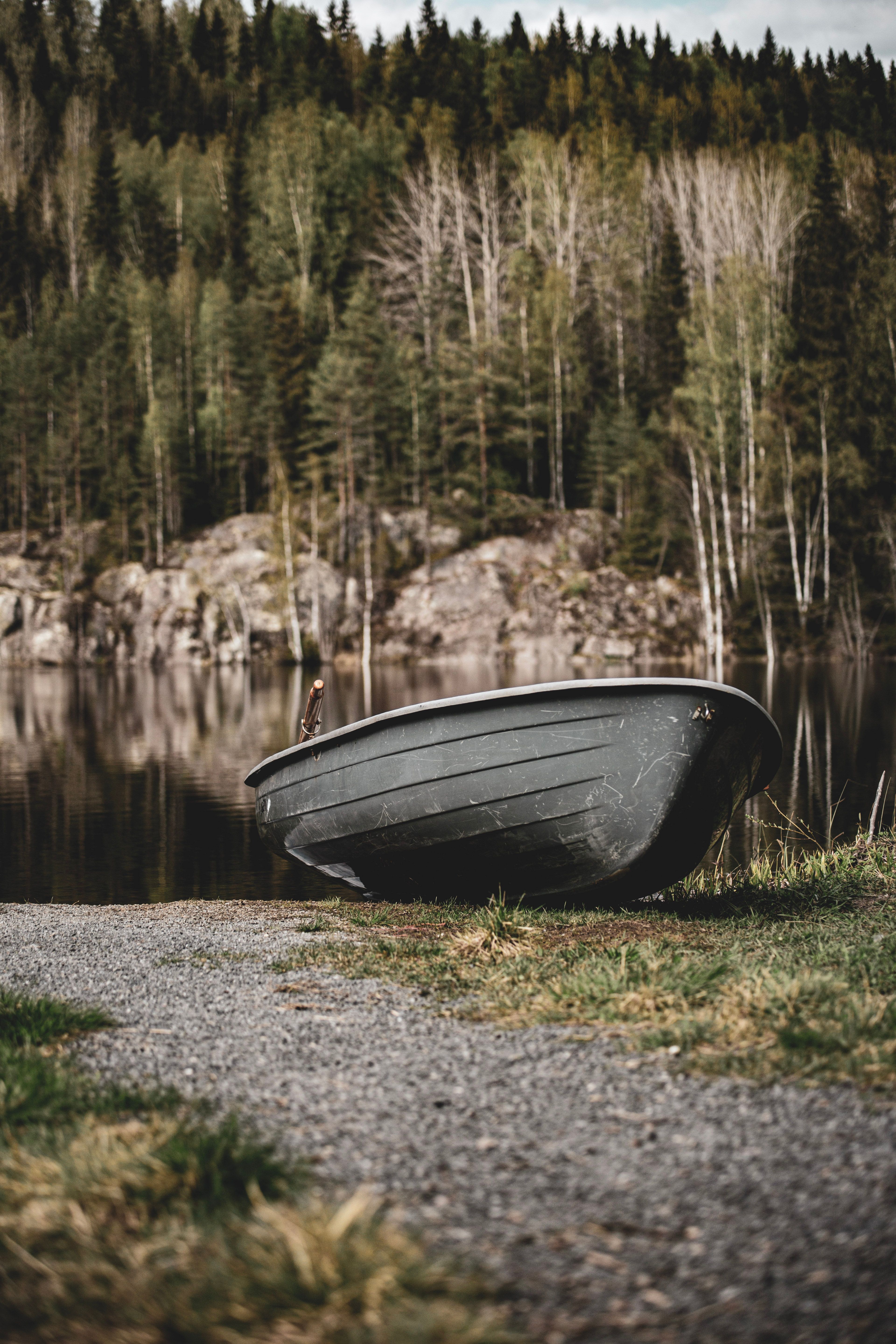 Rowboat on a River Bank in a Mountain Forest Landscape · Free Stock Photo