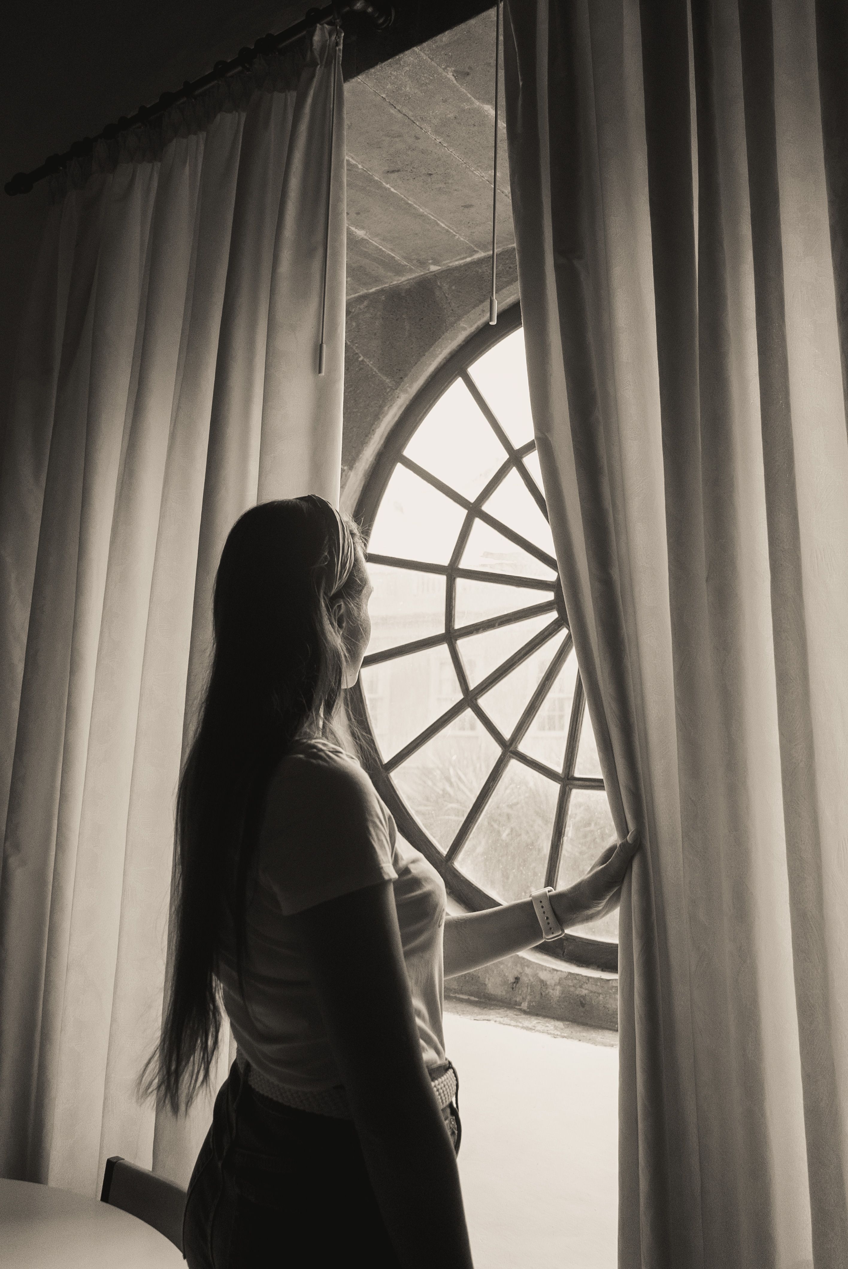 Woman Standing in an Open Window · Free Stock Photo