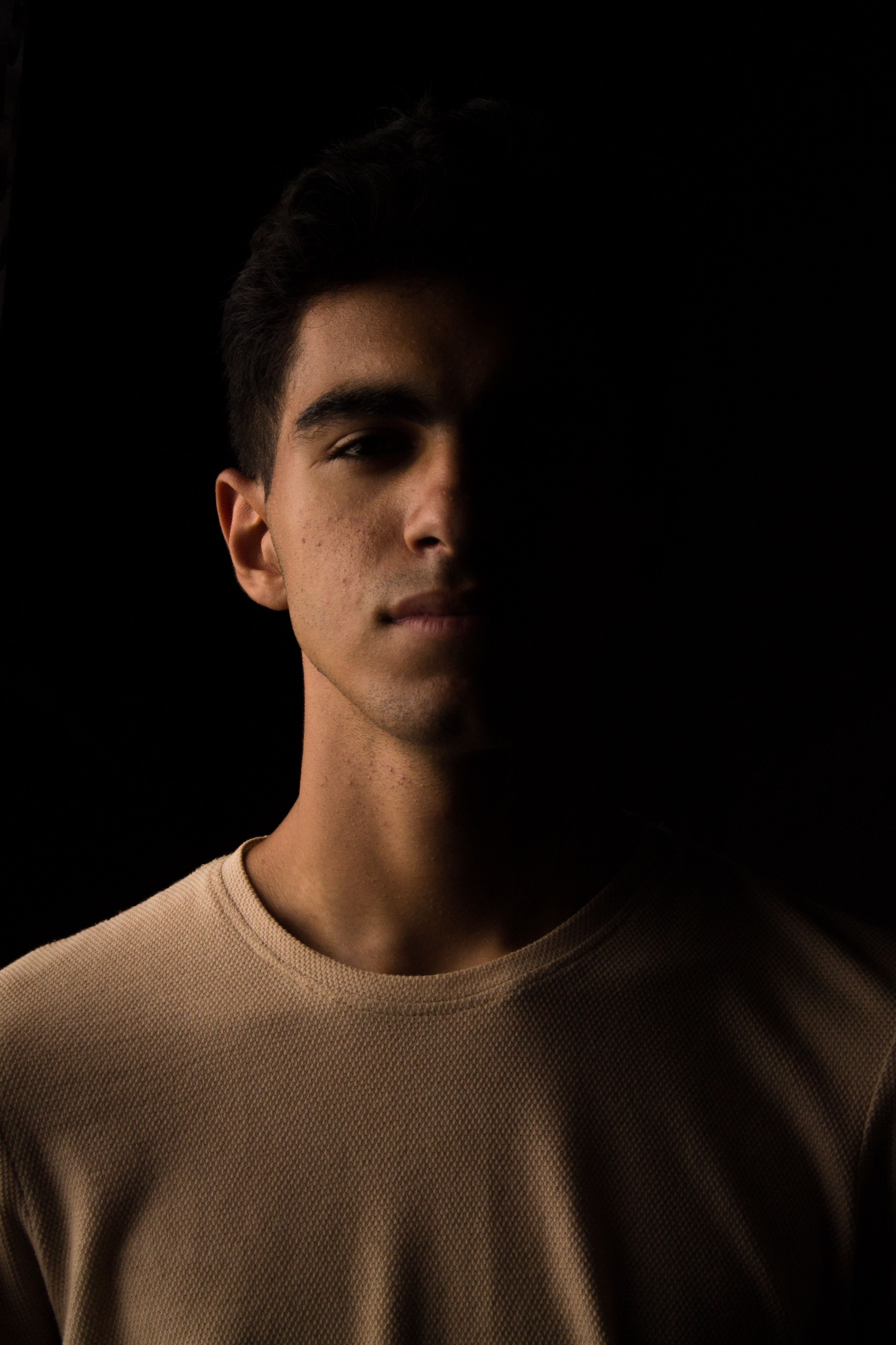 Dark Studio Shot of a Young Man · Free Stock Photo