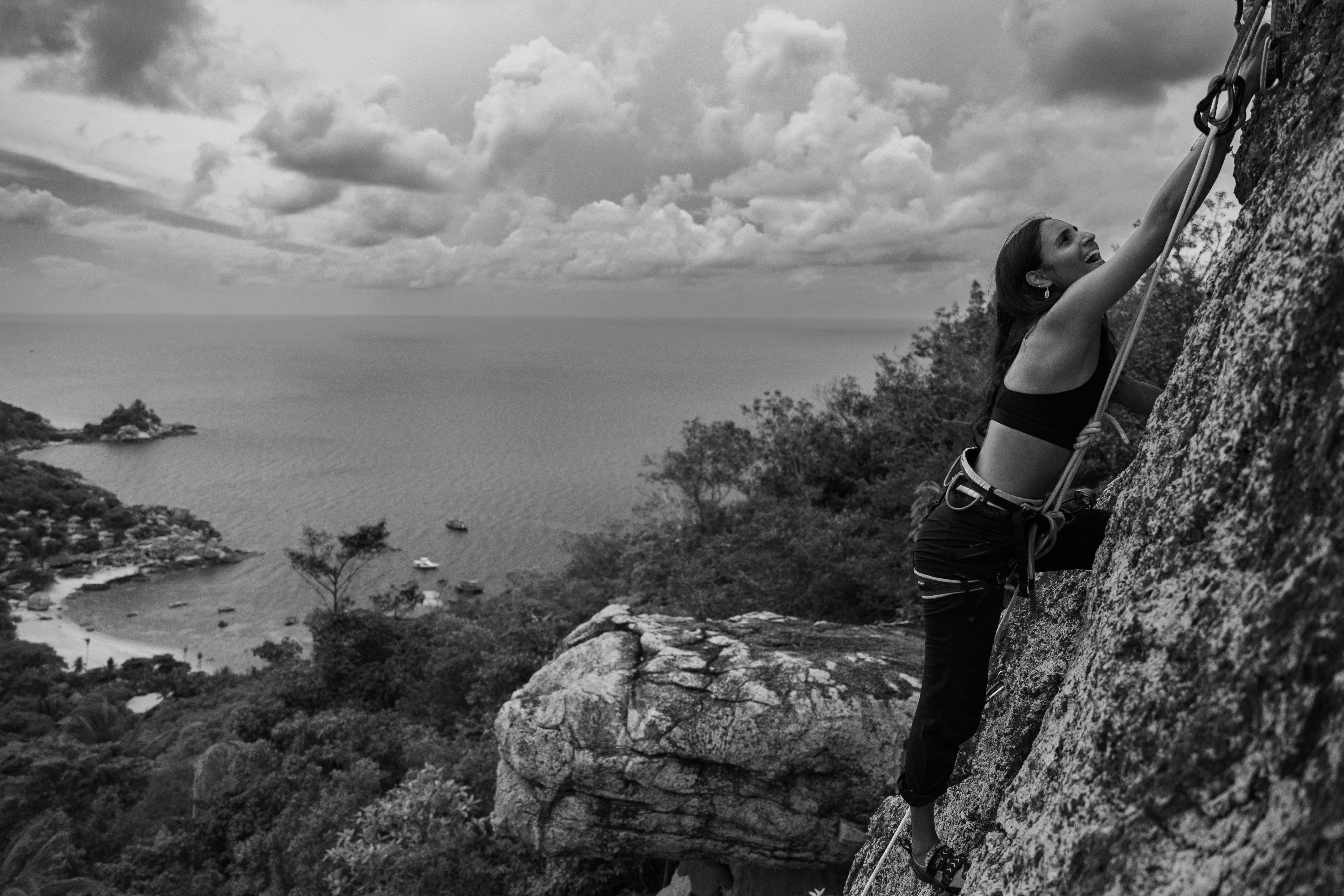 Smiling Woman Rock Climbing on Sea Coast · Free Stock Photo