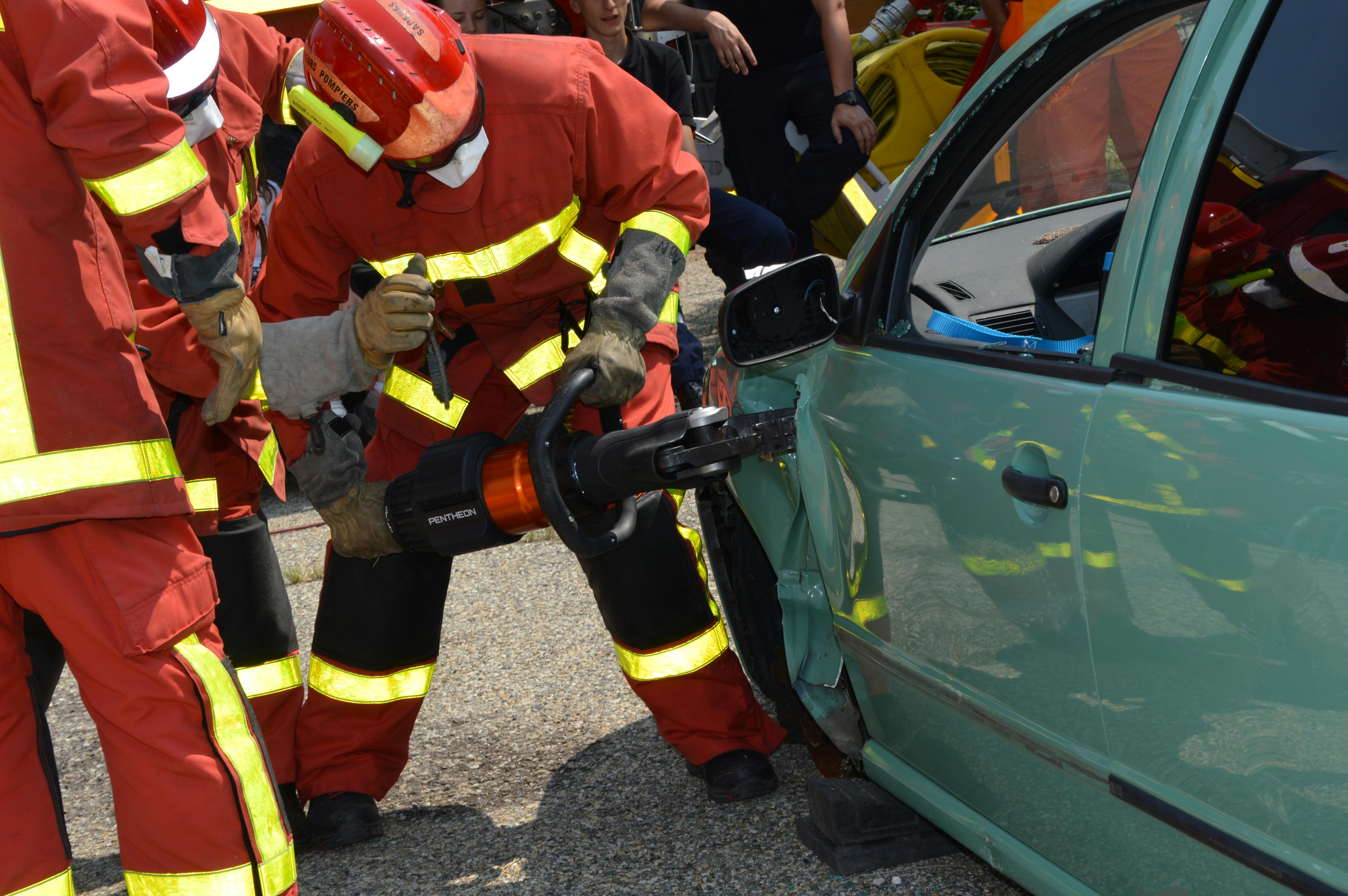 Firemen Spraying on Flaming Vehicle · Free Stock Photo