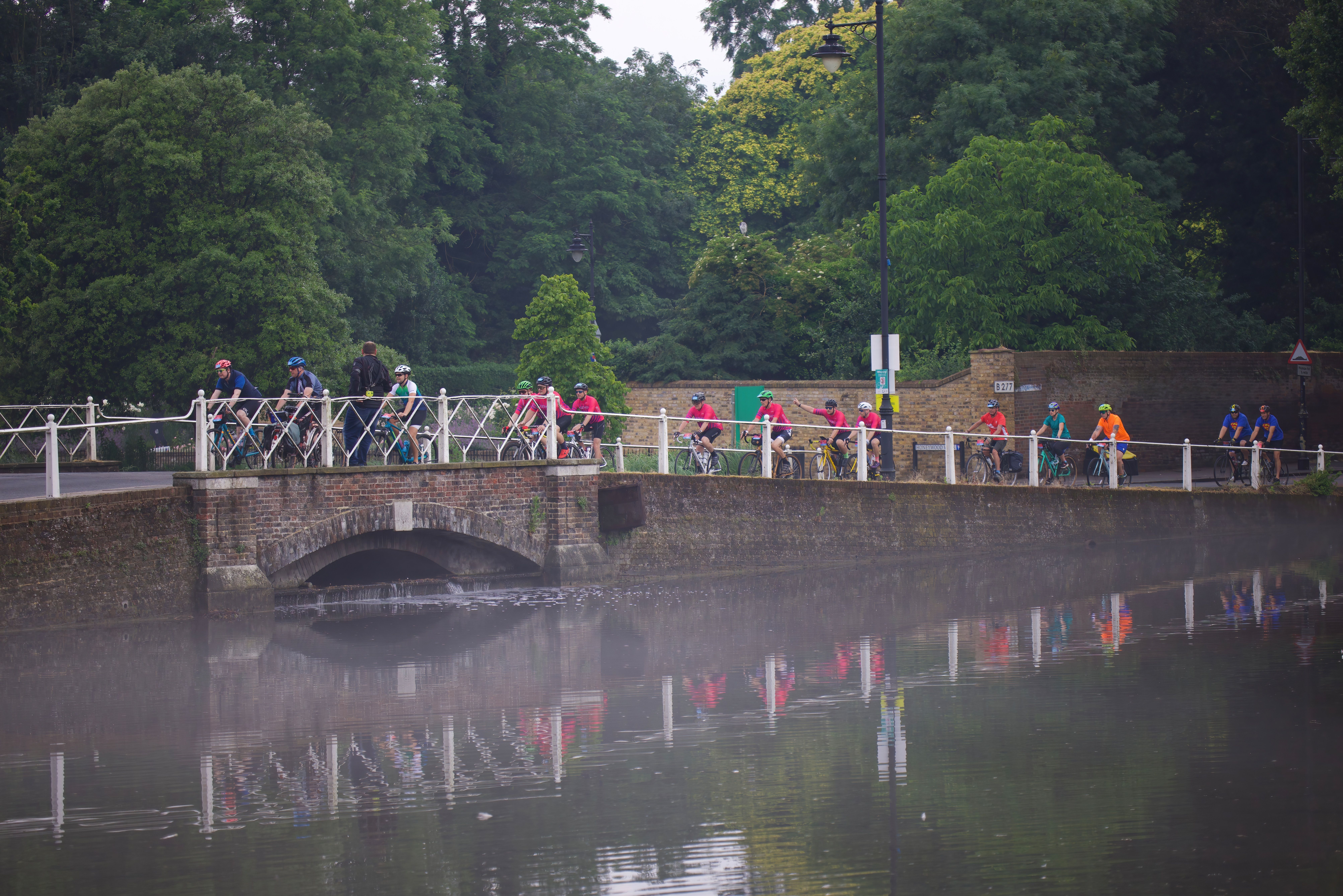 A group of people are crossing a bridge · Free Stock Photo