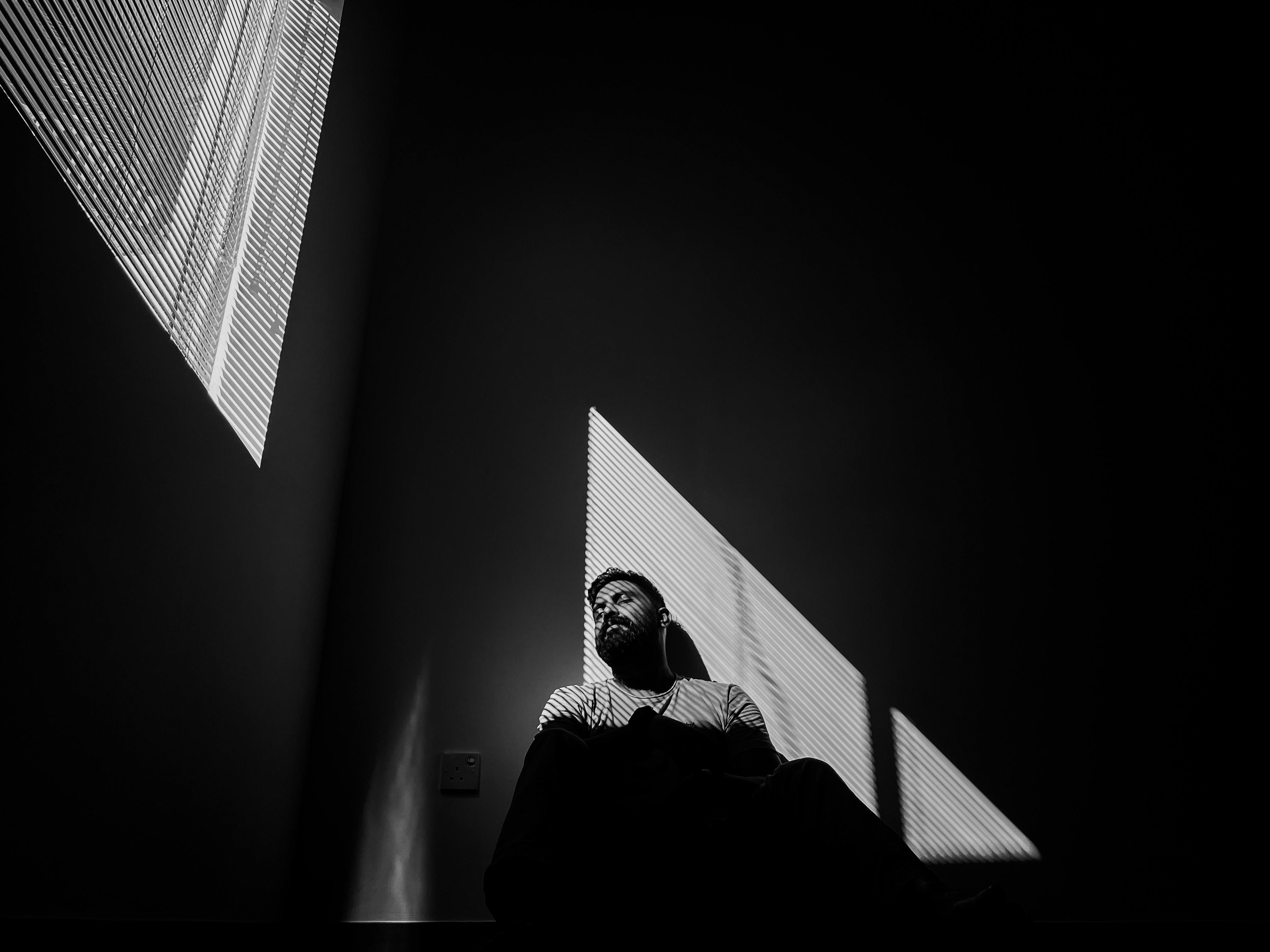 Bearded Man Posing in Shadow near Wall · Free Stock Photo