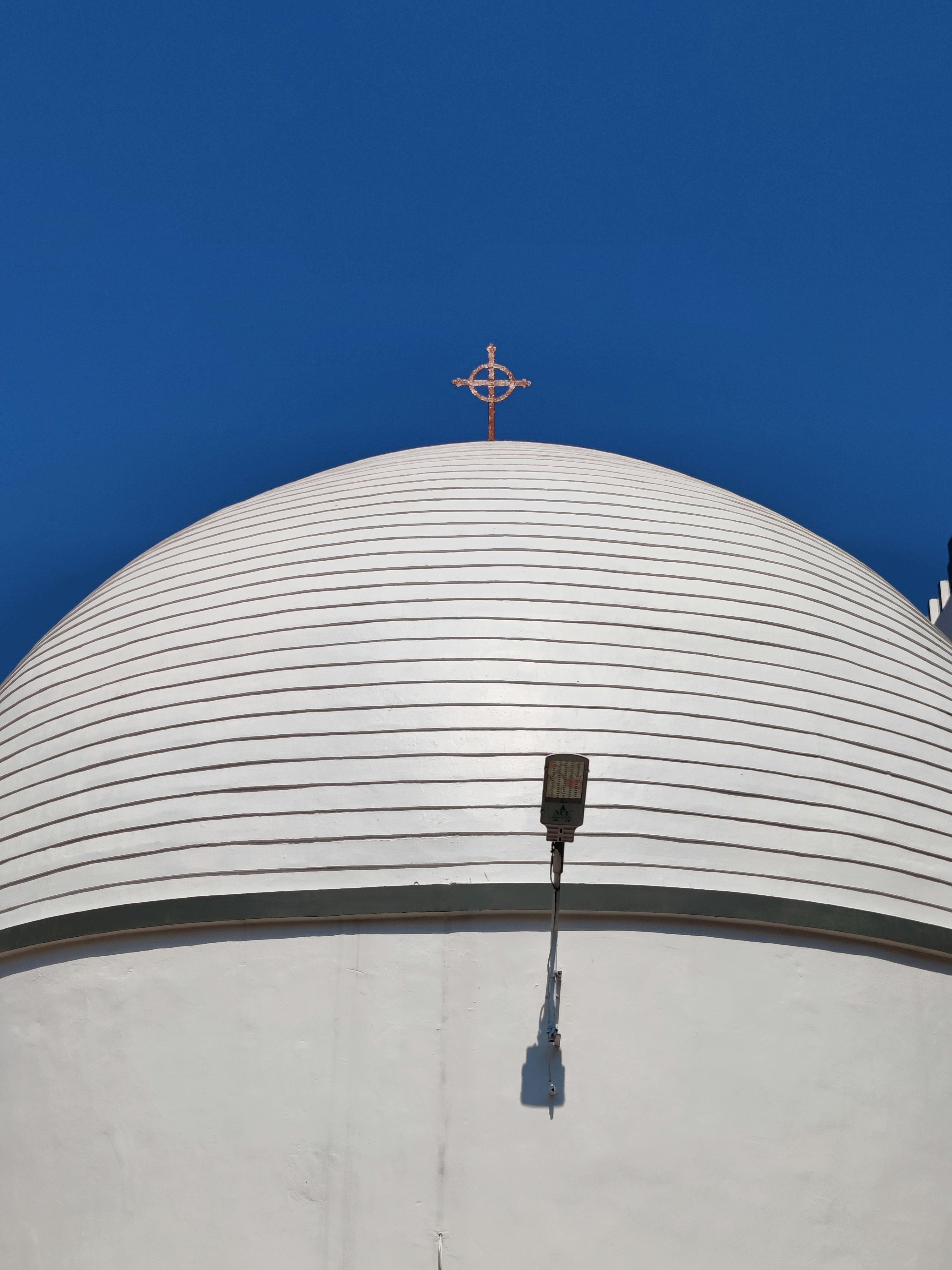 Cross over Sunlit Church Wall · Free Stock Photo