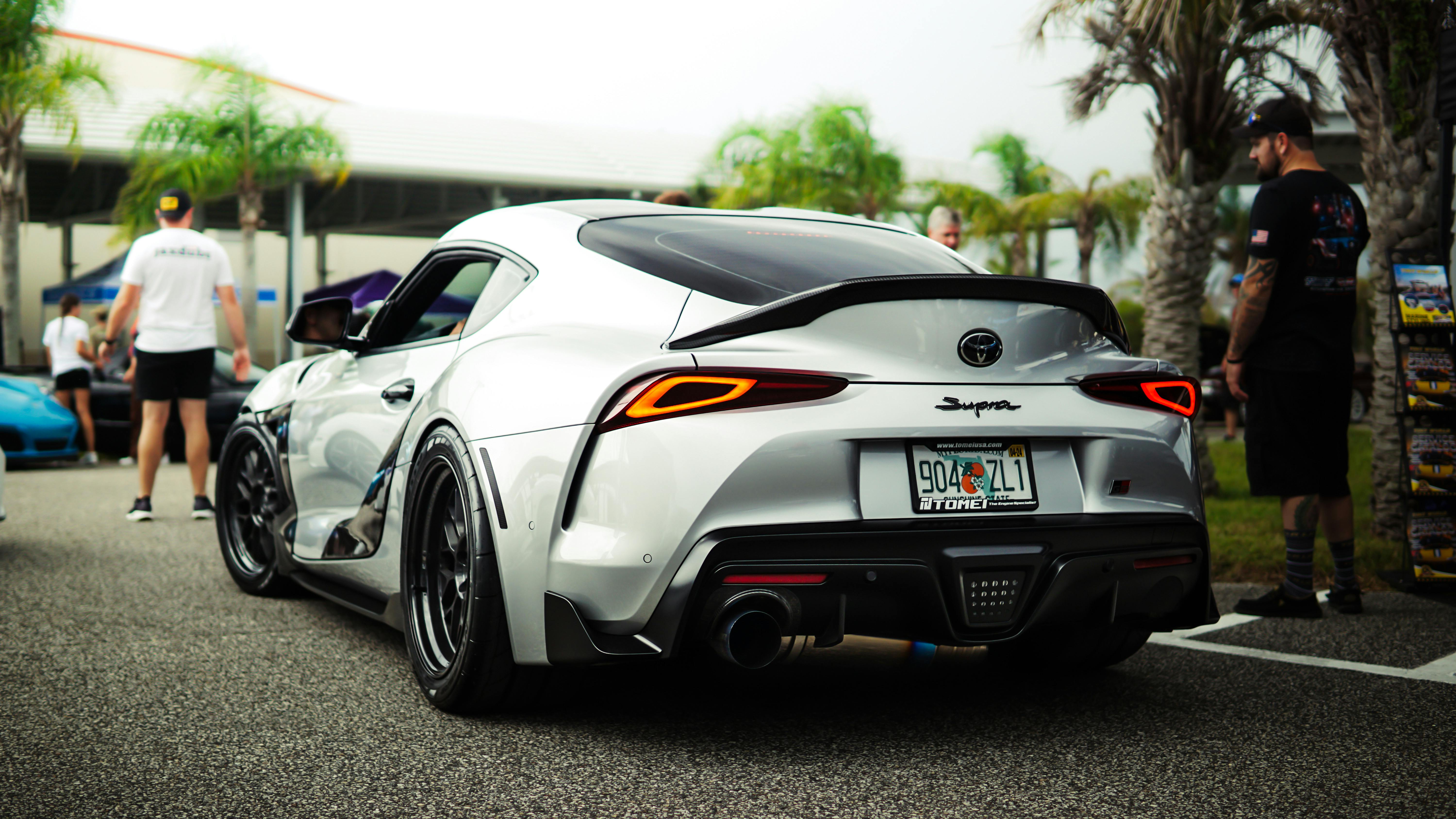A Modern White Toyota Supra at a Car Event · Free Stock Photo