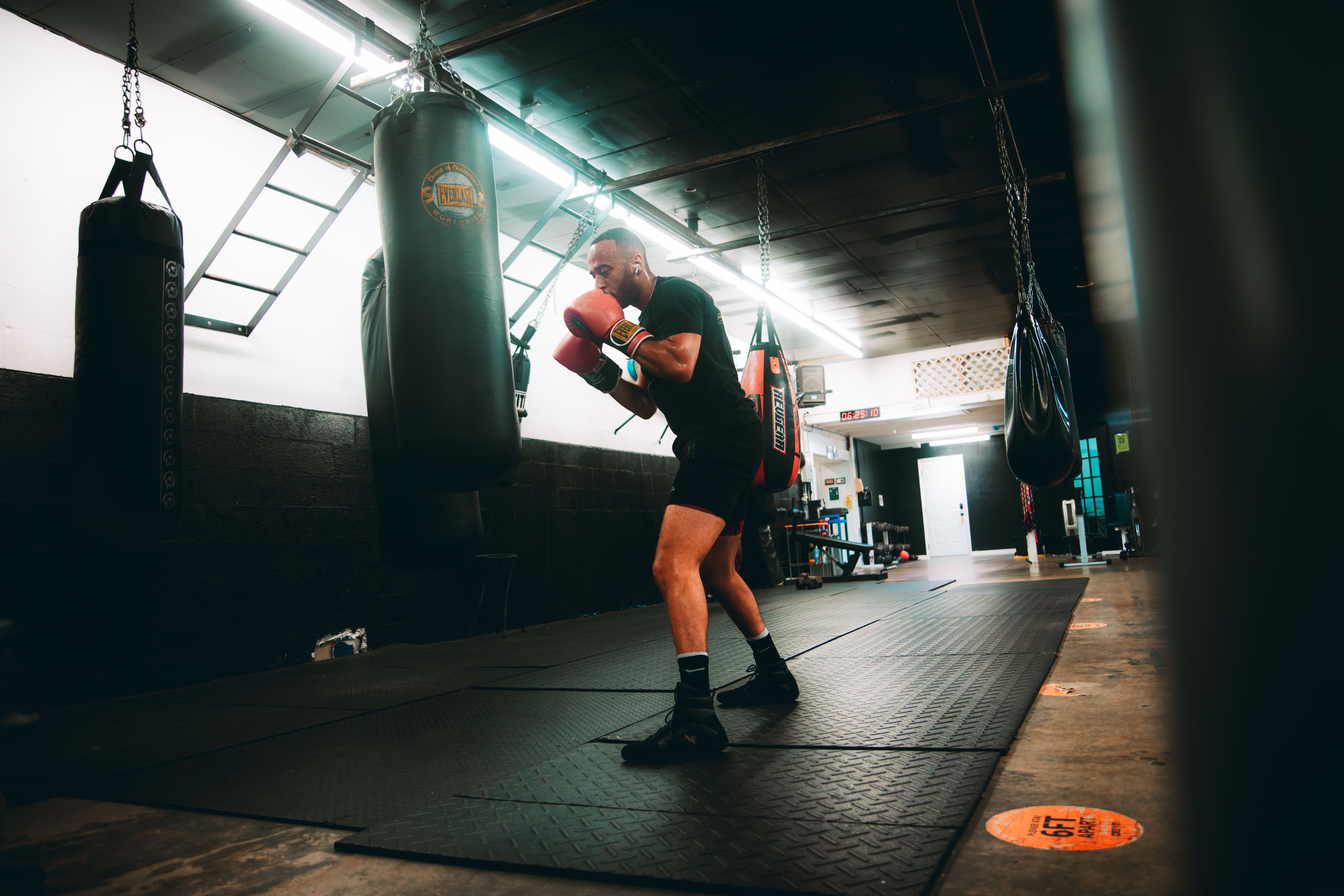 Man Kicking the Black Punching Bag · Free Stock Photo