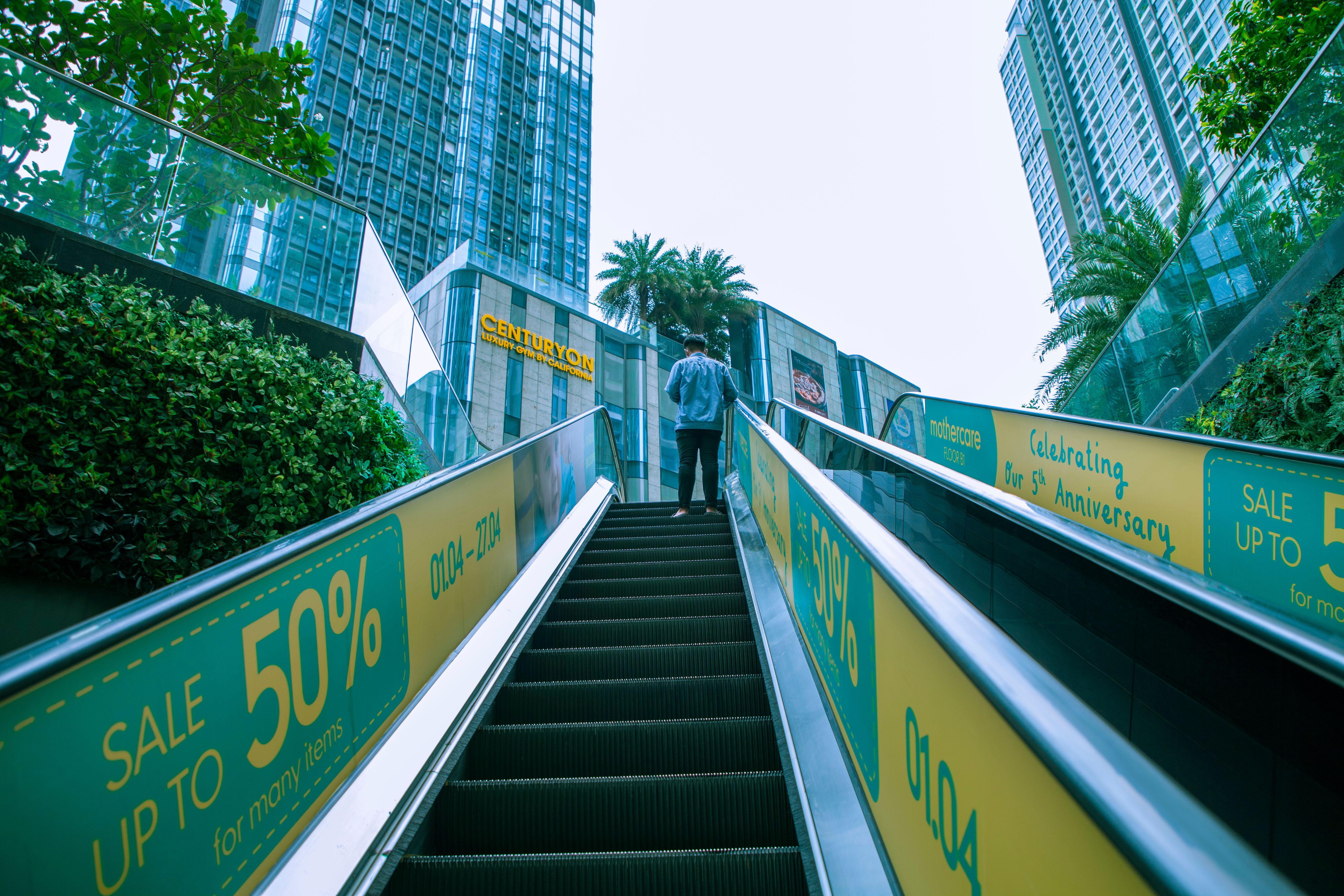 Man on Escalators in City · Free Stock Photo