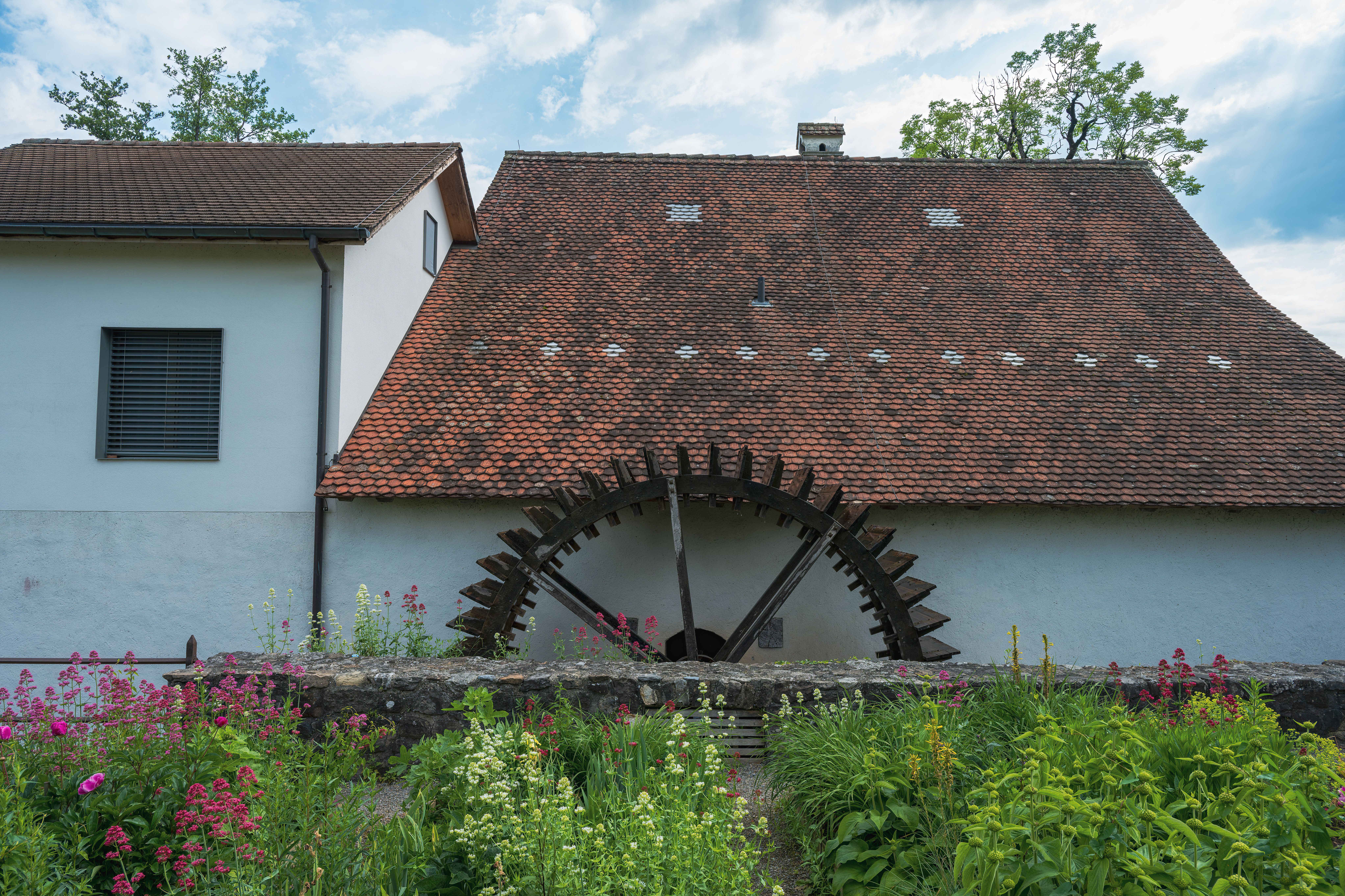 Exterior of an Old Building with a Water Wheel · Free Stock Photo