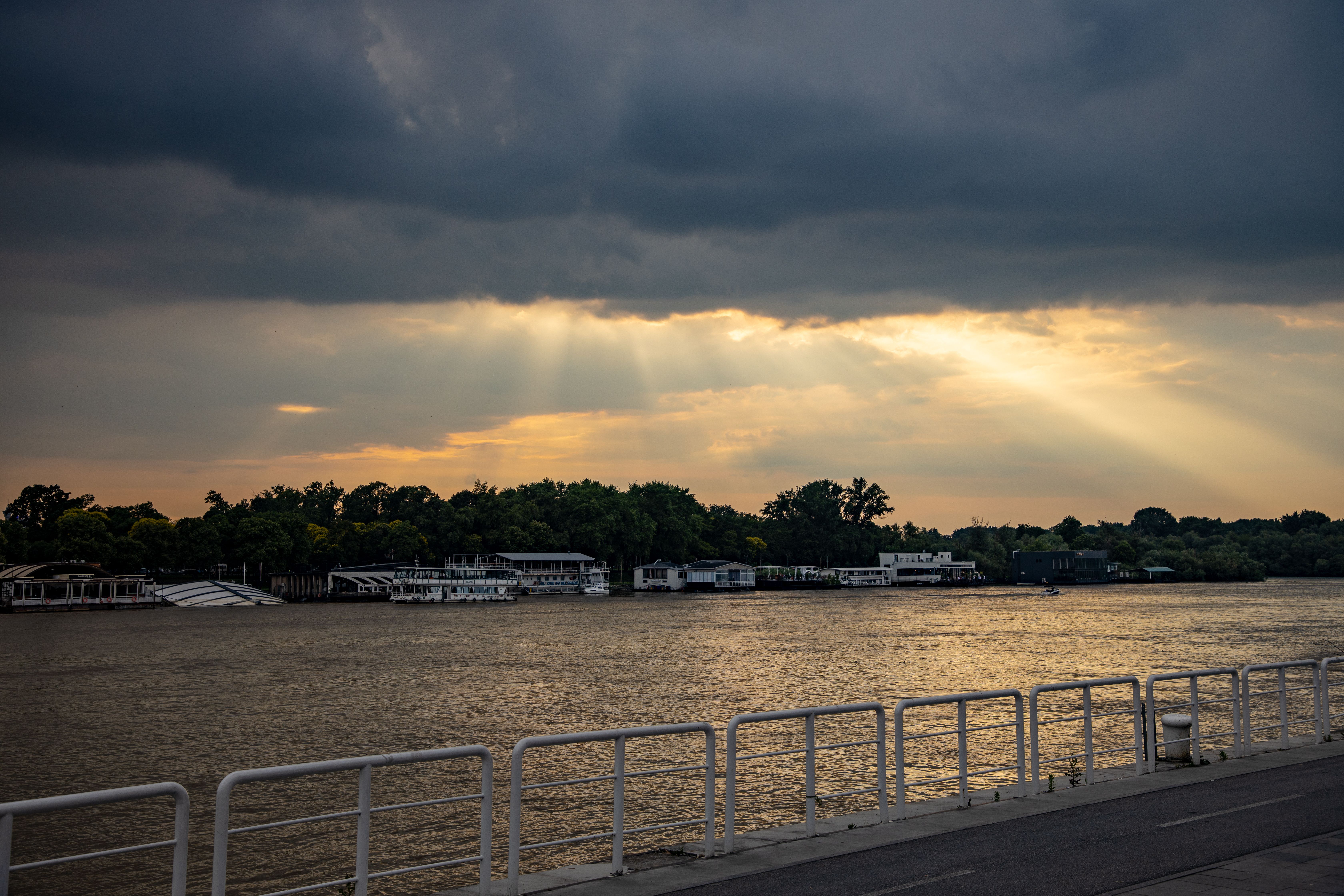 Sunbeams over River under Rain Clouds · Free Stock Photo