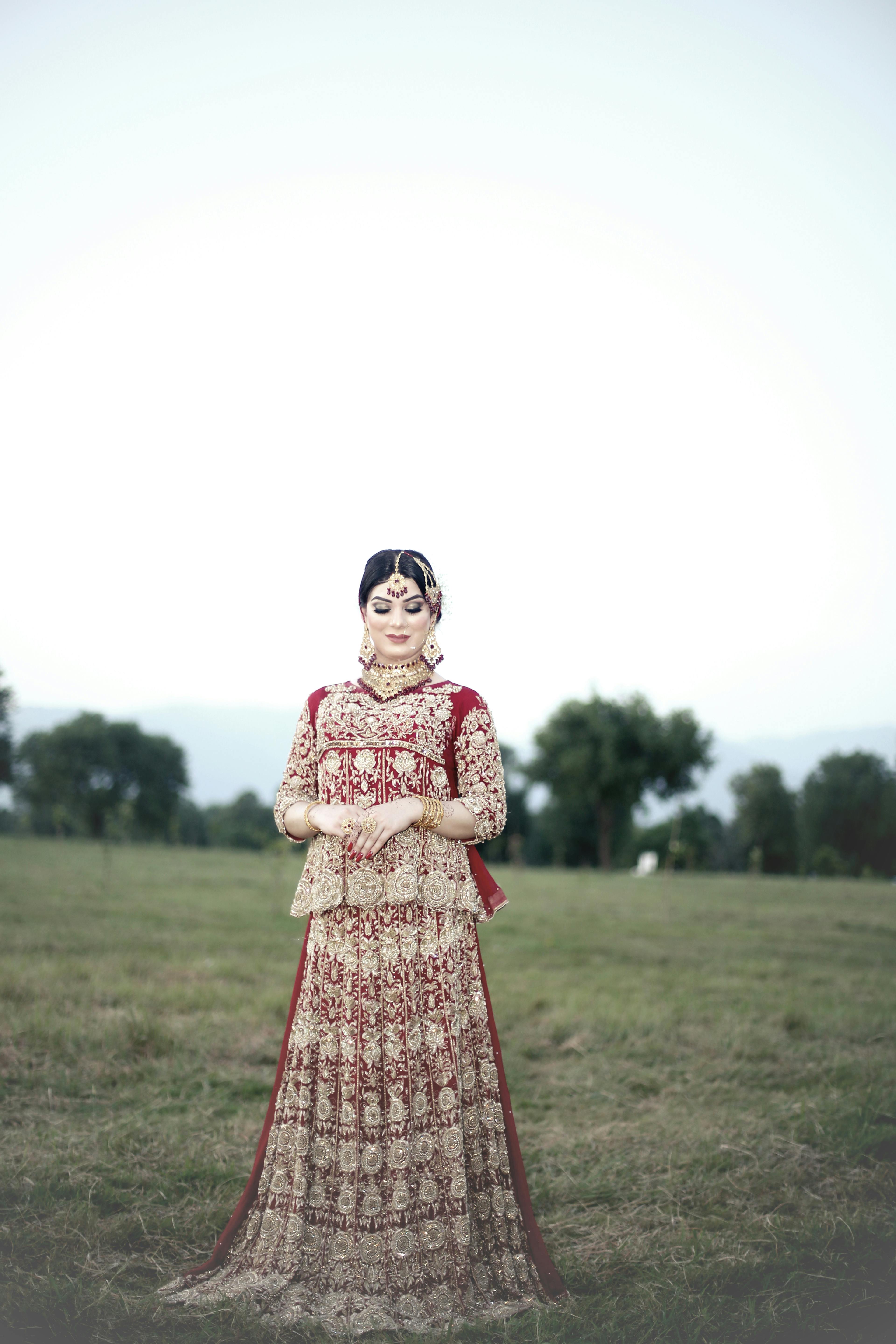 Woman in Traditional Dress on Grassland · Free Stock Photo