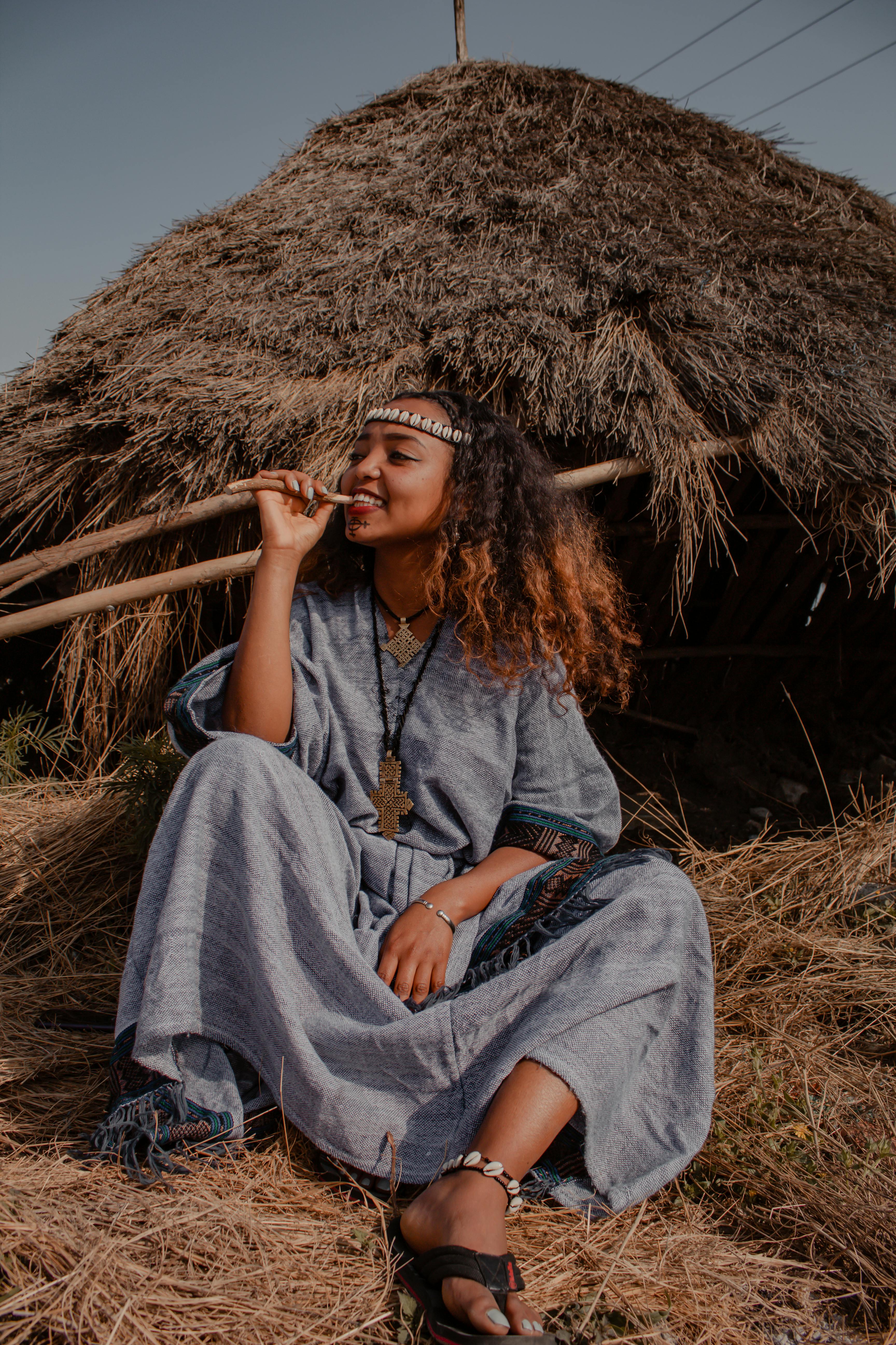 Smiling Woman in front of Modest Hut · Free Stock Photo